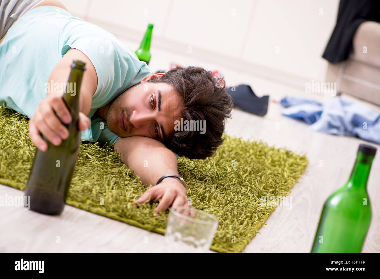 Young drunk handsome man after party at home Stock Photo - Alamy