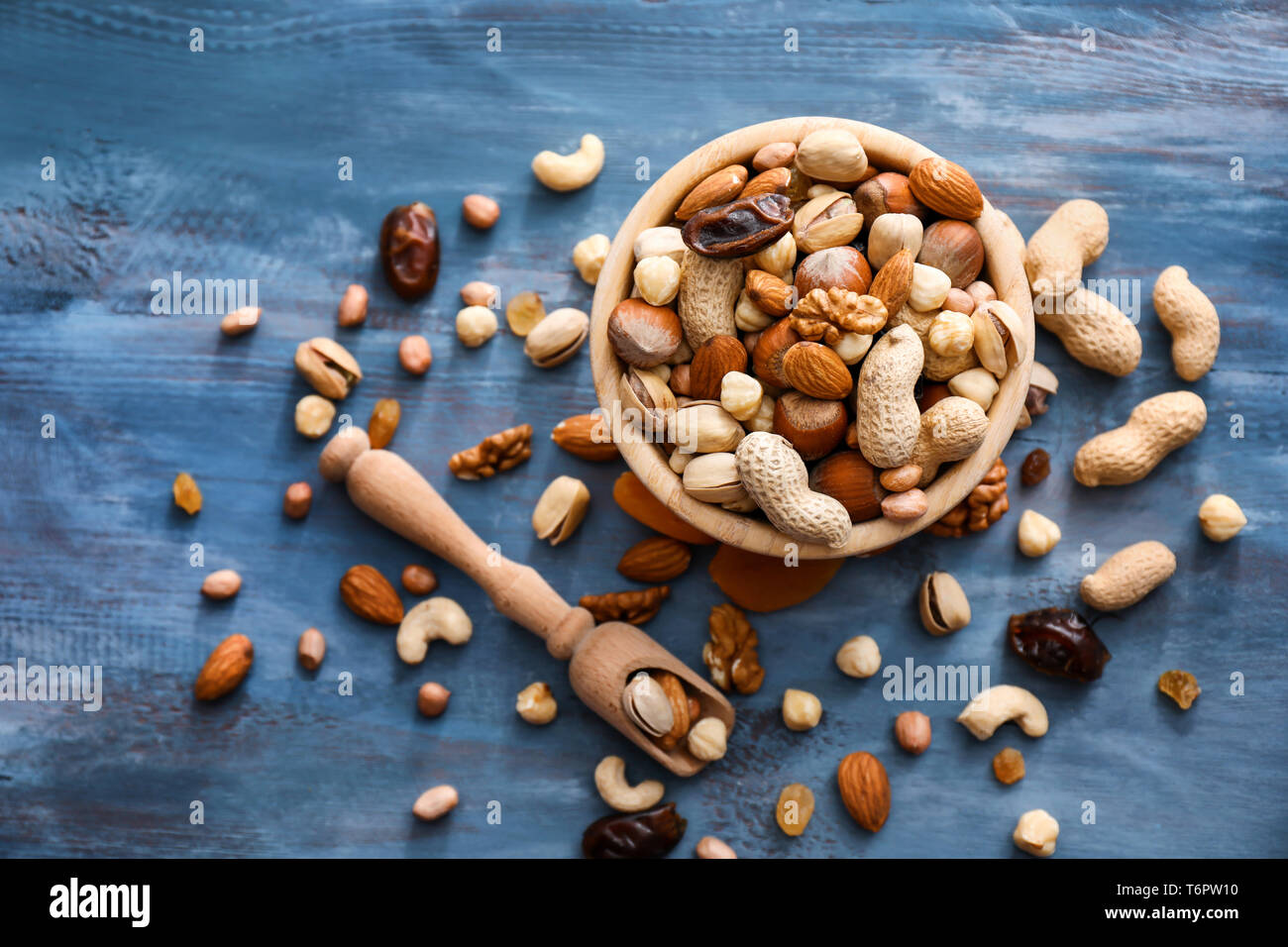 Various tasty nuts with bowl and scoop on color background Stock Photo ...