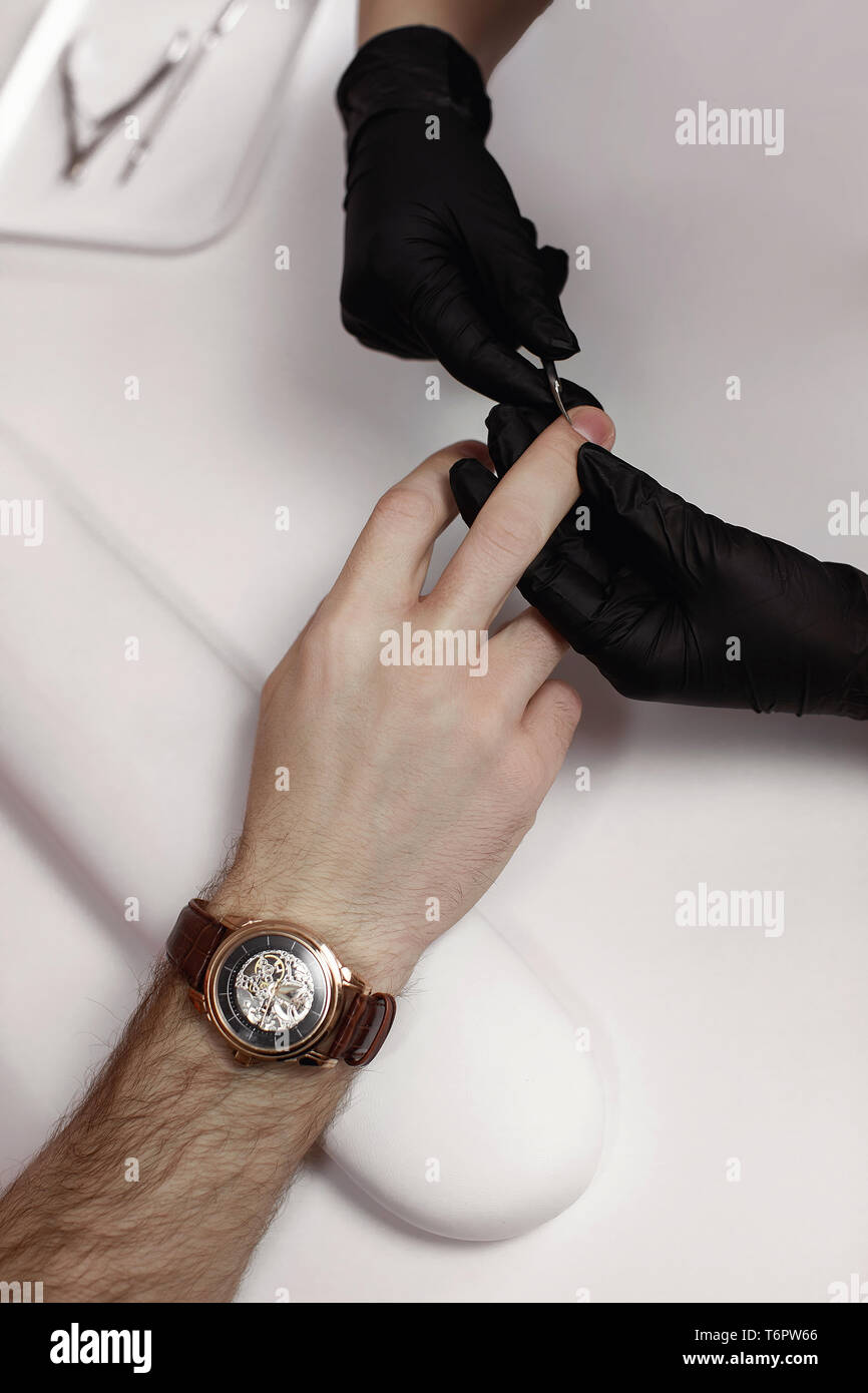 The man on procedures in manicure salon. Spa, manicuring, removal of ...