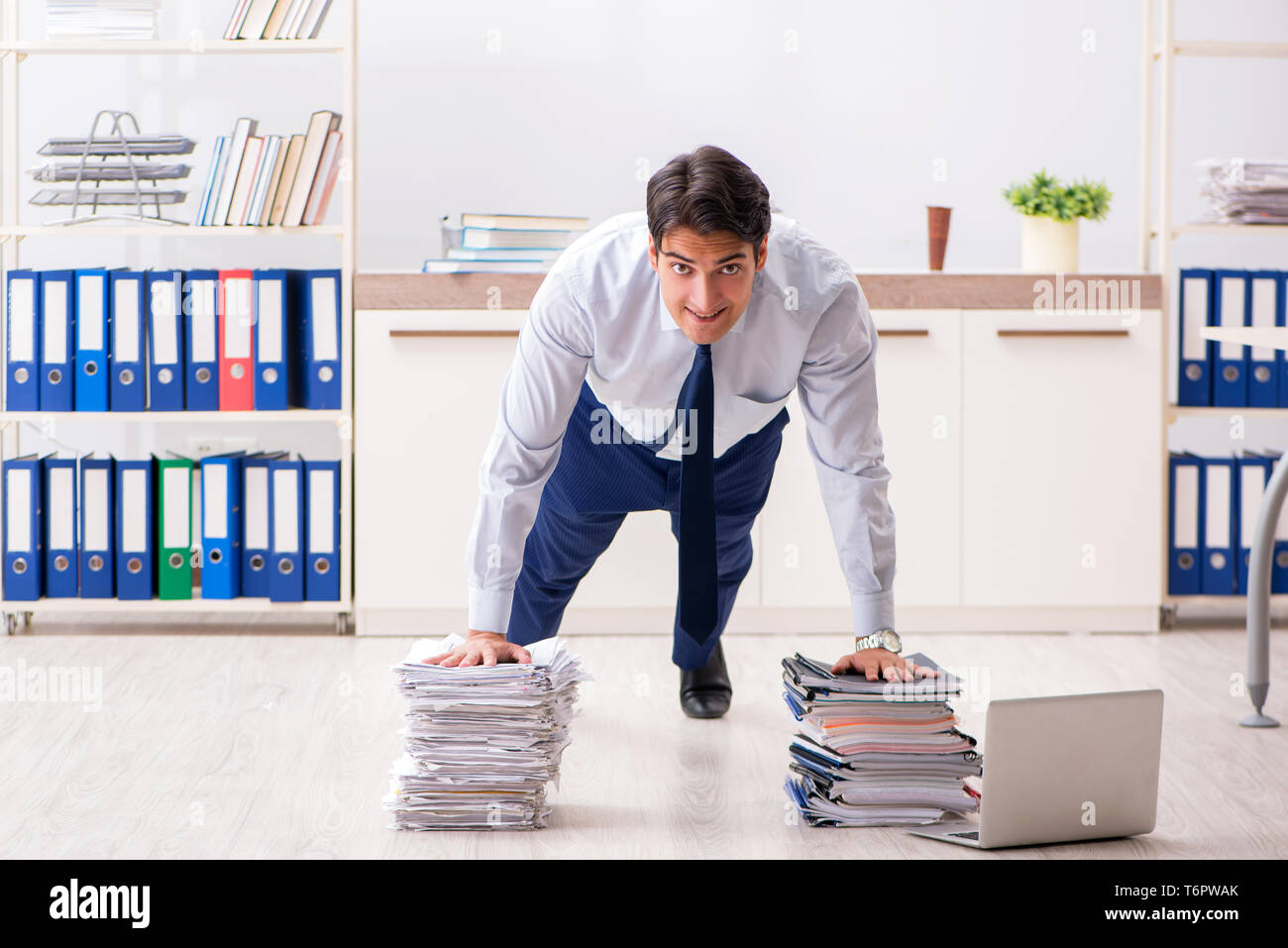Extremely busy employee working in the office Stock Photo - Alamy