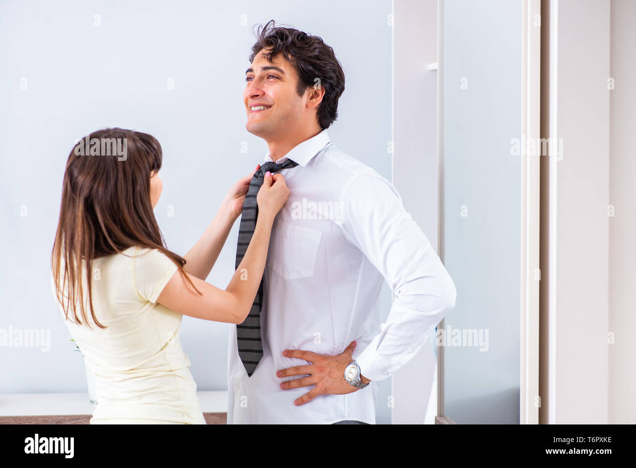 Woman sees her husband off to work Stock Photo - Alamy