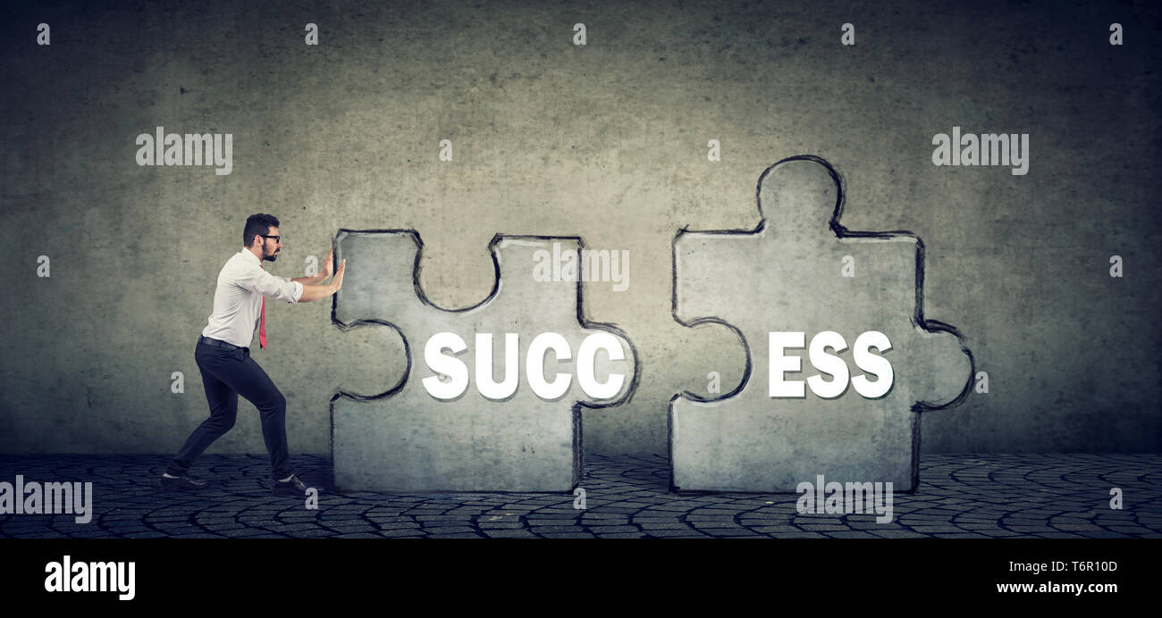 Confident business man pushing parts of success puzzle Stock Photo - Alamy