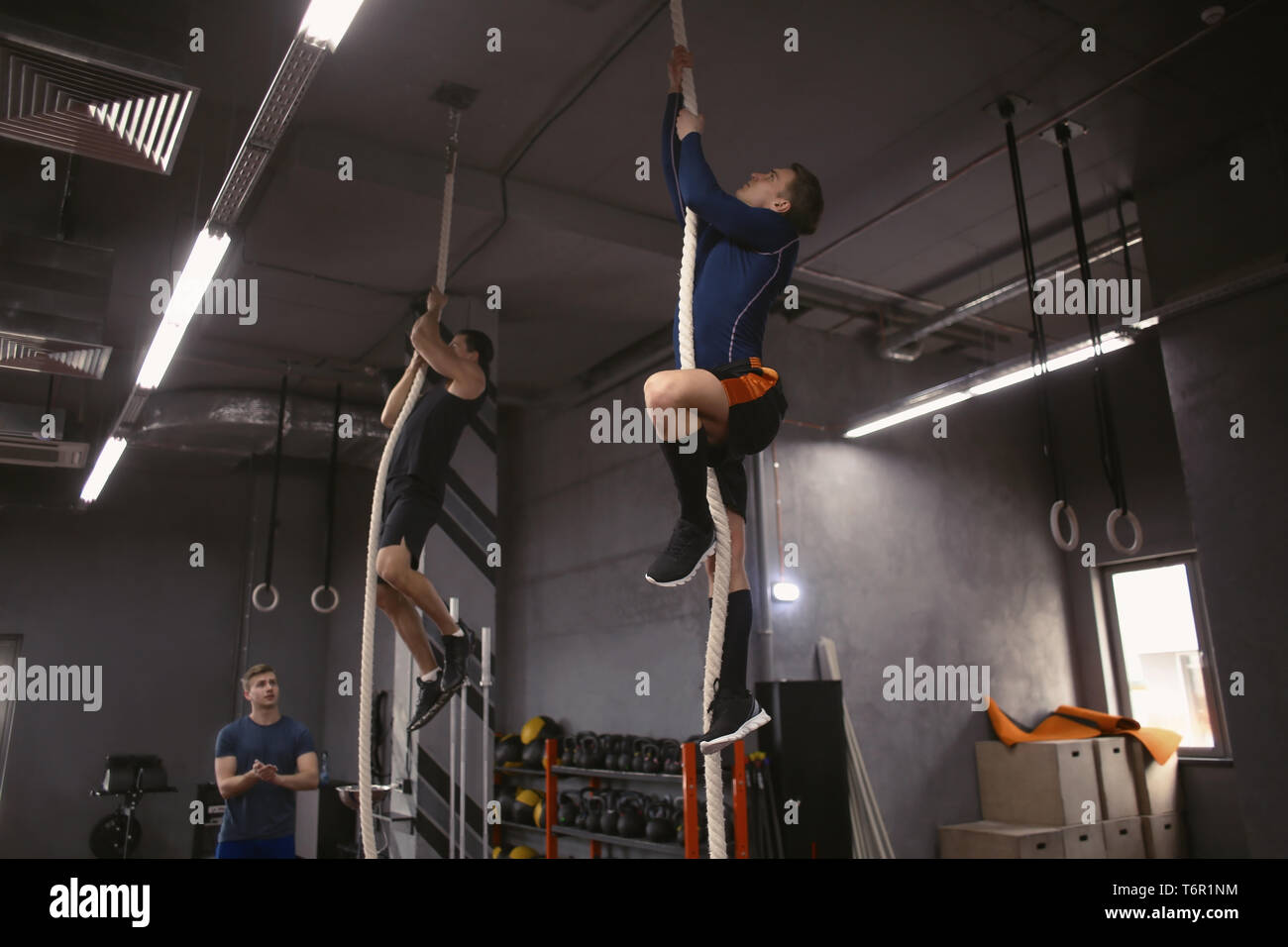 Young men climbing hi-res stock photography and images - Alamy