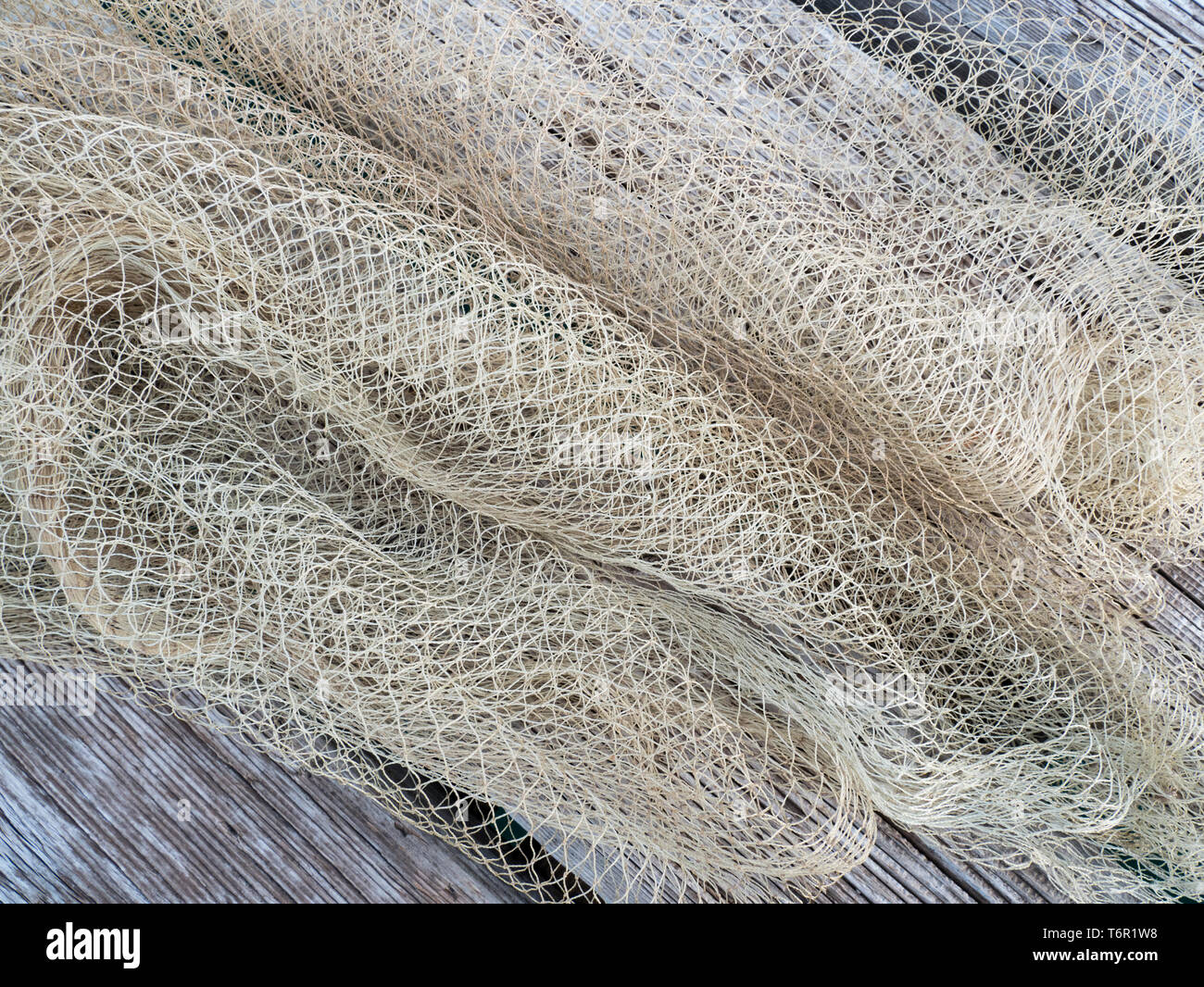 Old fishing net on wooden dock outdoors Stock Photo - Alamy