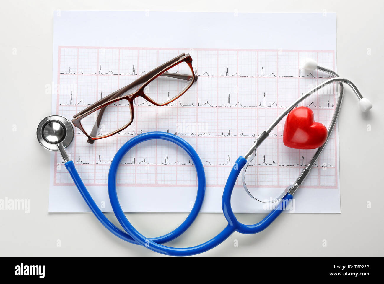 Cardiogram with stethoscope and eyeglasses on white background Stock ...