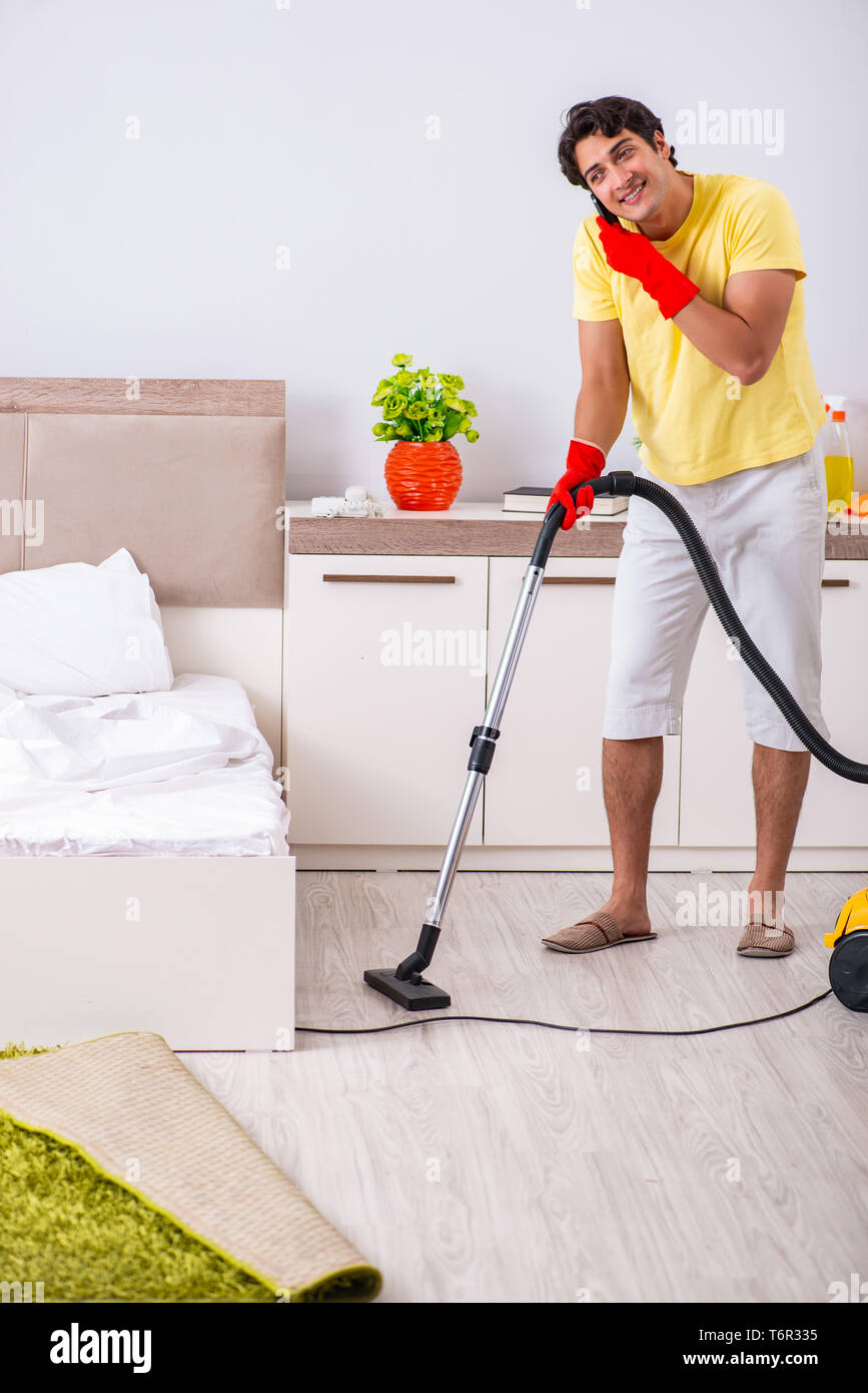 Man vacuuming bed hi-res stock photography and images - Alamy