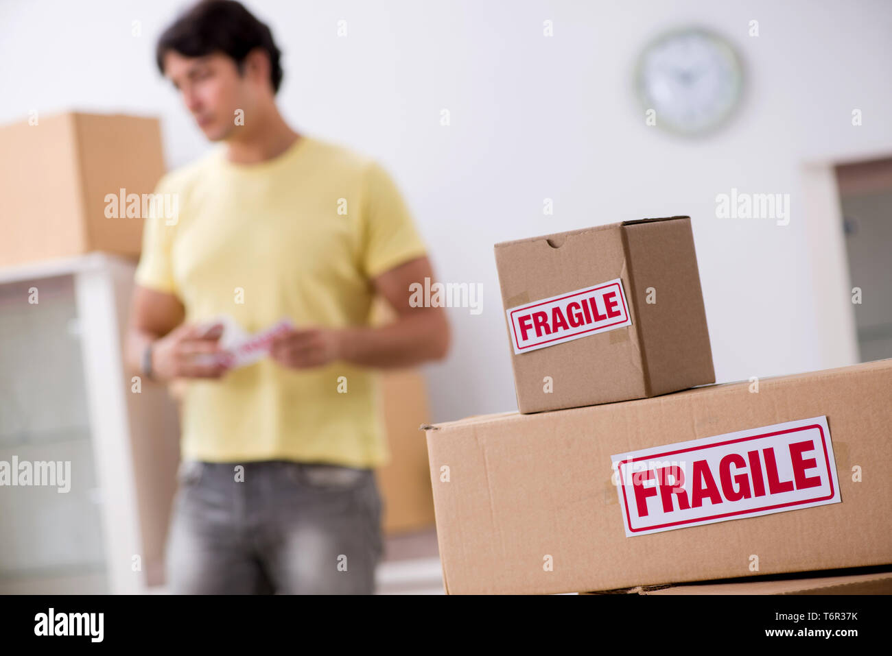 Man moving house and relocating with fragile items Stock Photo - Alamy