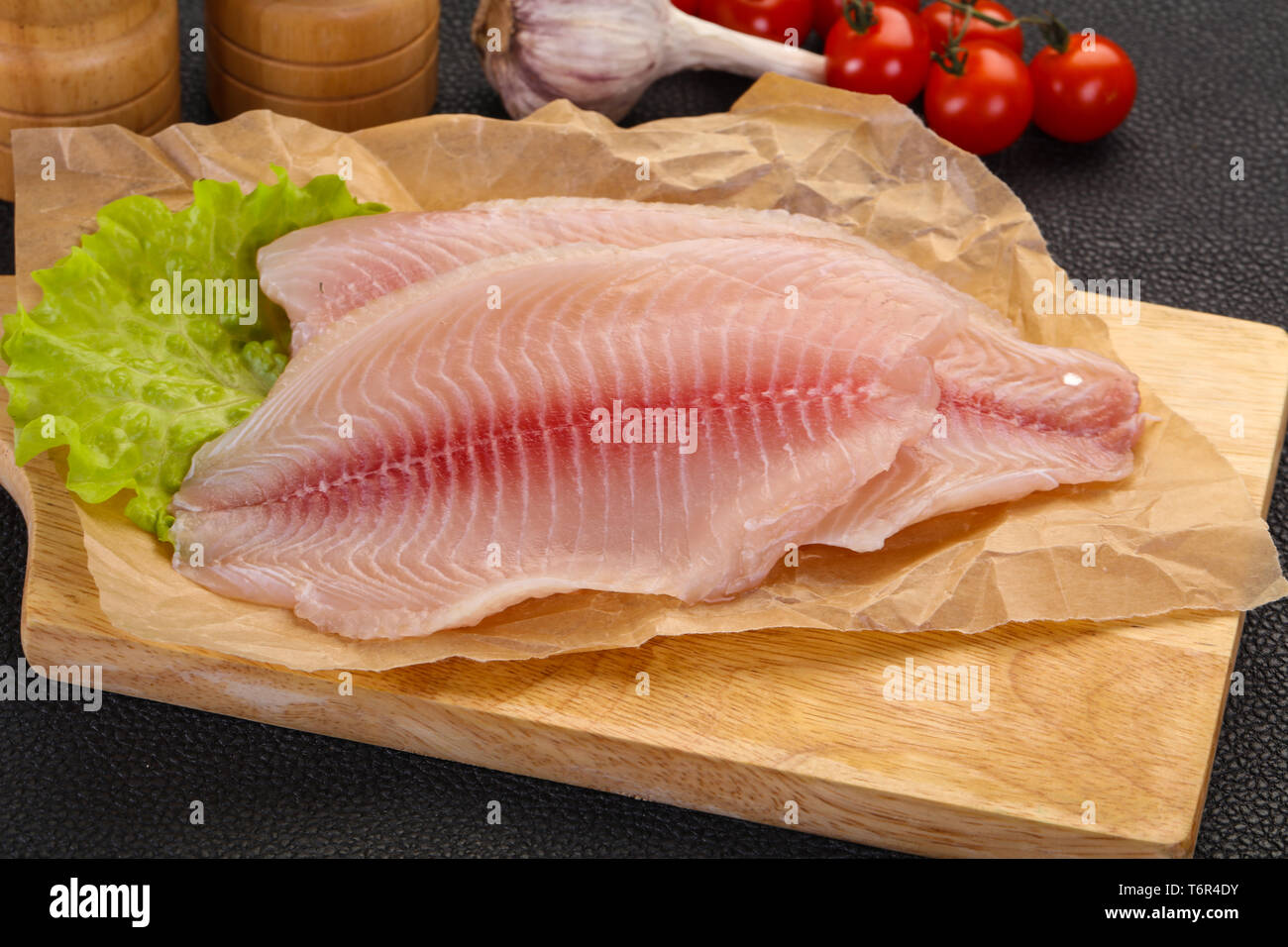 Raw tilapia fish ready for cooking Stock Photo - Alamy