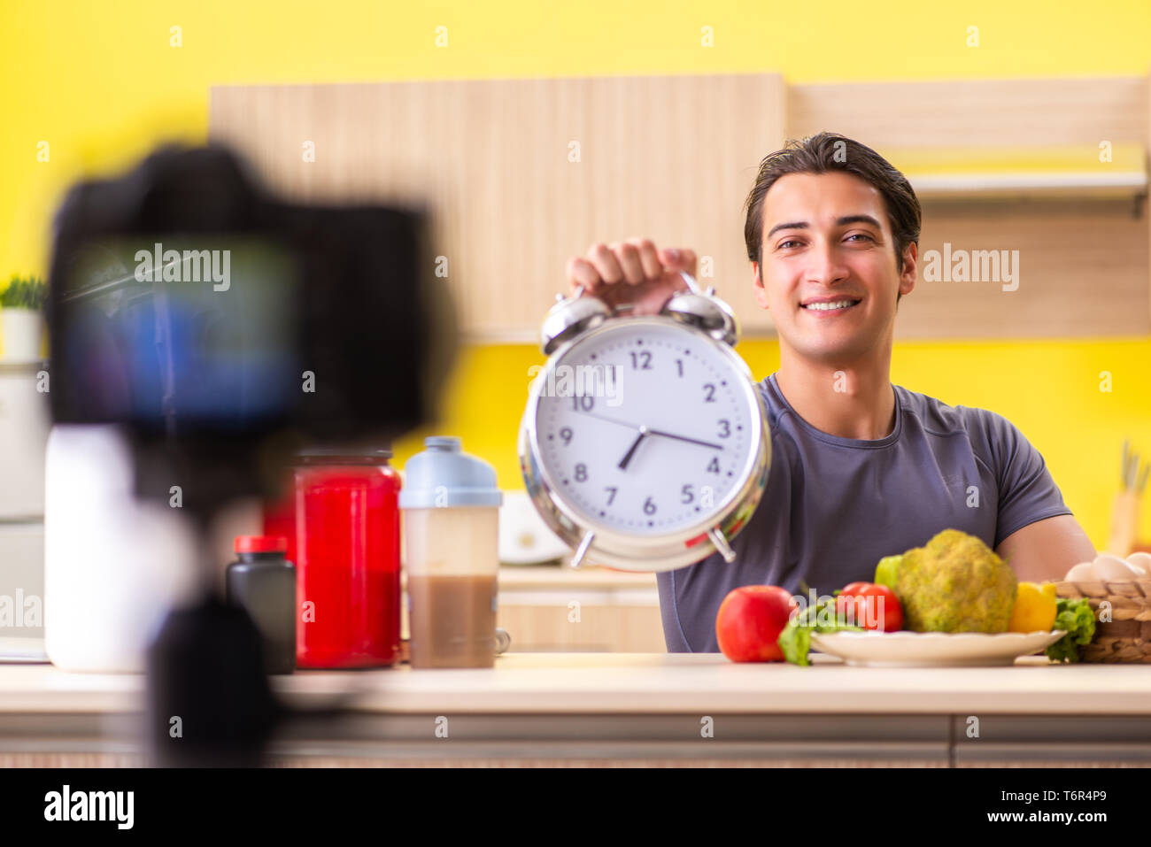 Young man blogging about food supplements Stock Photo - Alamy