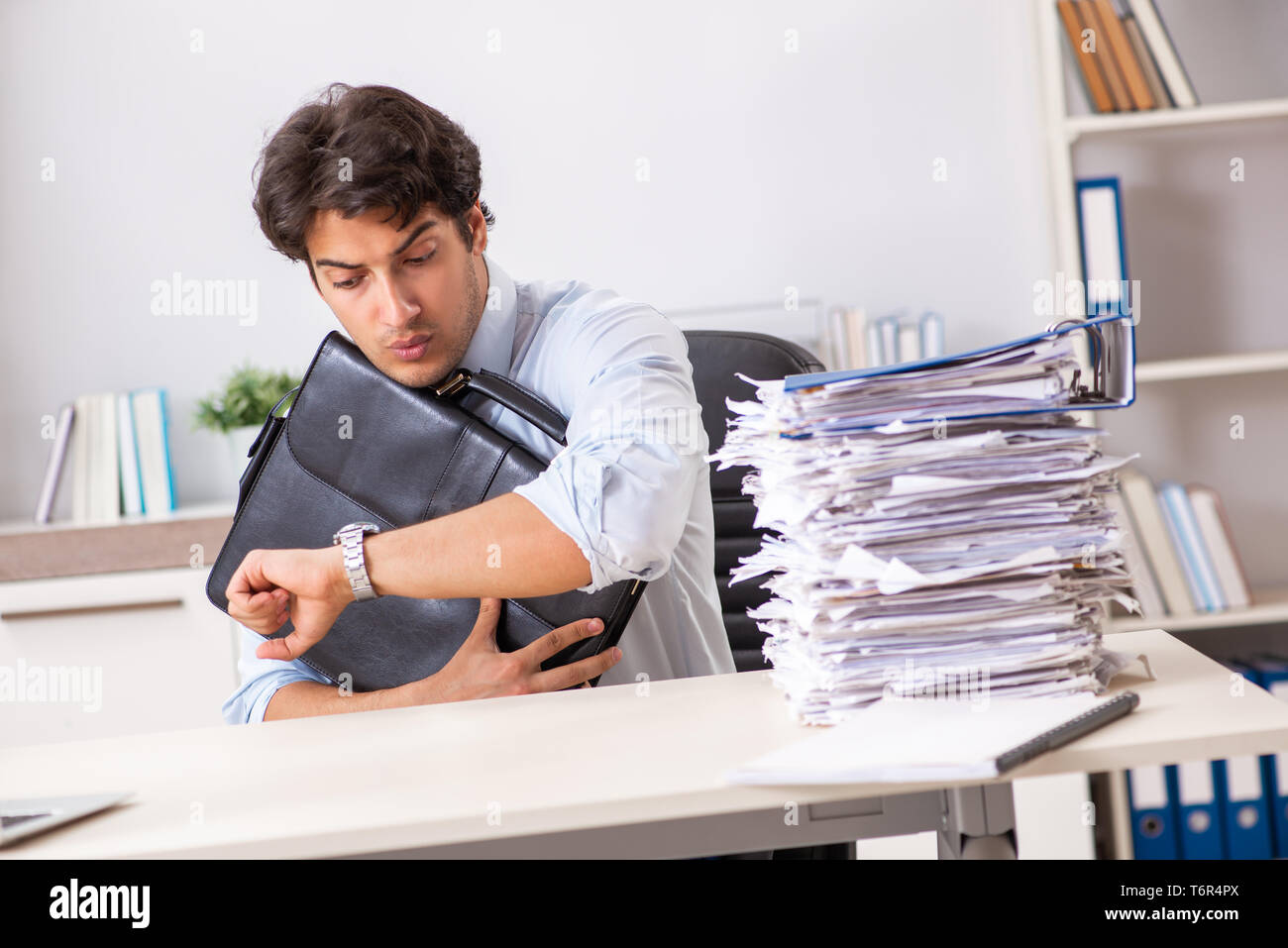 Overloaded busy employee with too much work and paperwork Stock Photo ...