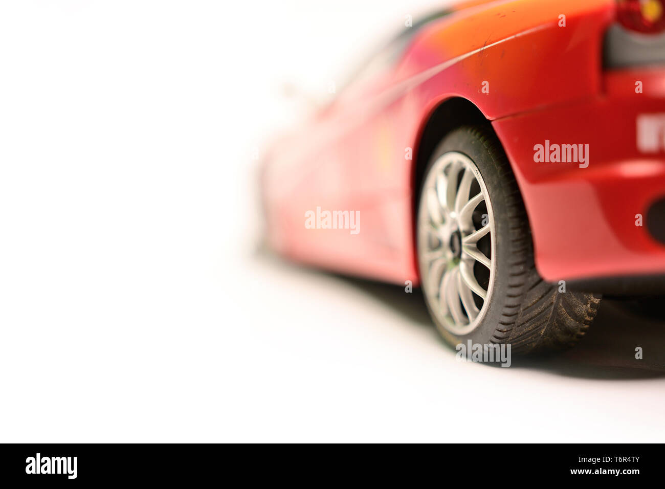 Red sports car model rear view on white background Stock Photo - Alamy