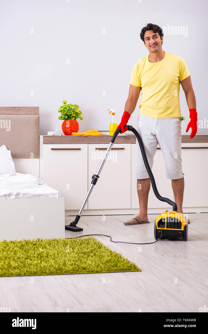 Man vacuuming bed hi-res stock photography and images - Alamy