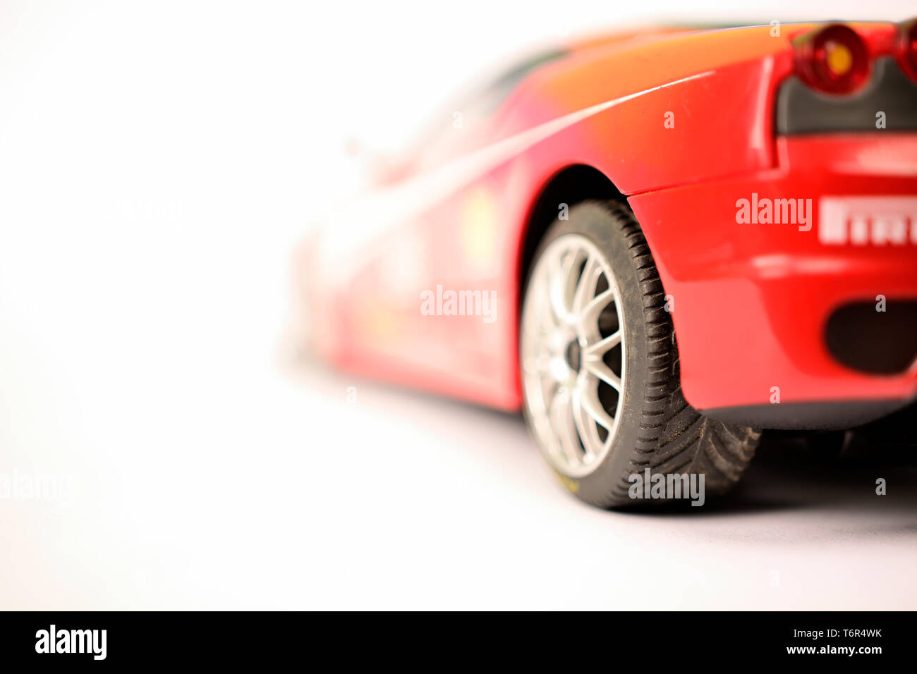 Red sports car model rear view on white background Stock Photo - Alamy