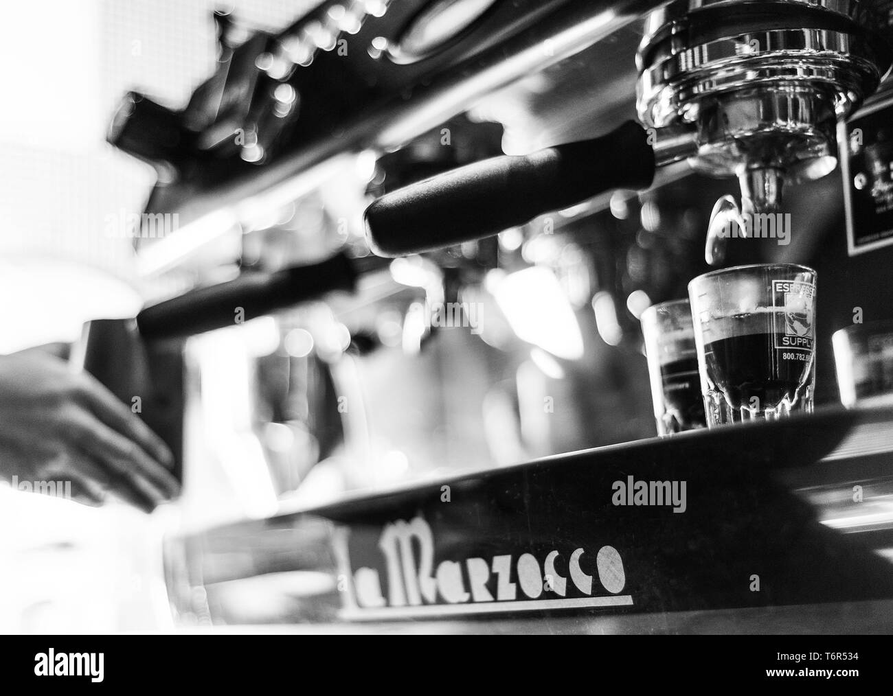making espresso coffee BW black and white close up detail with modern ...