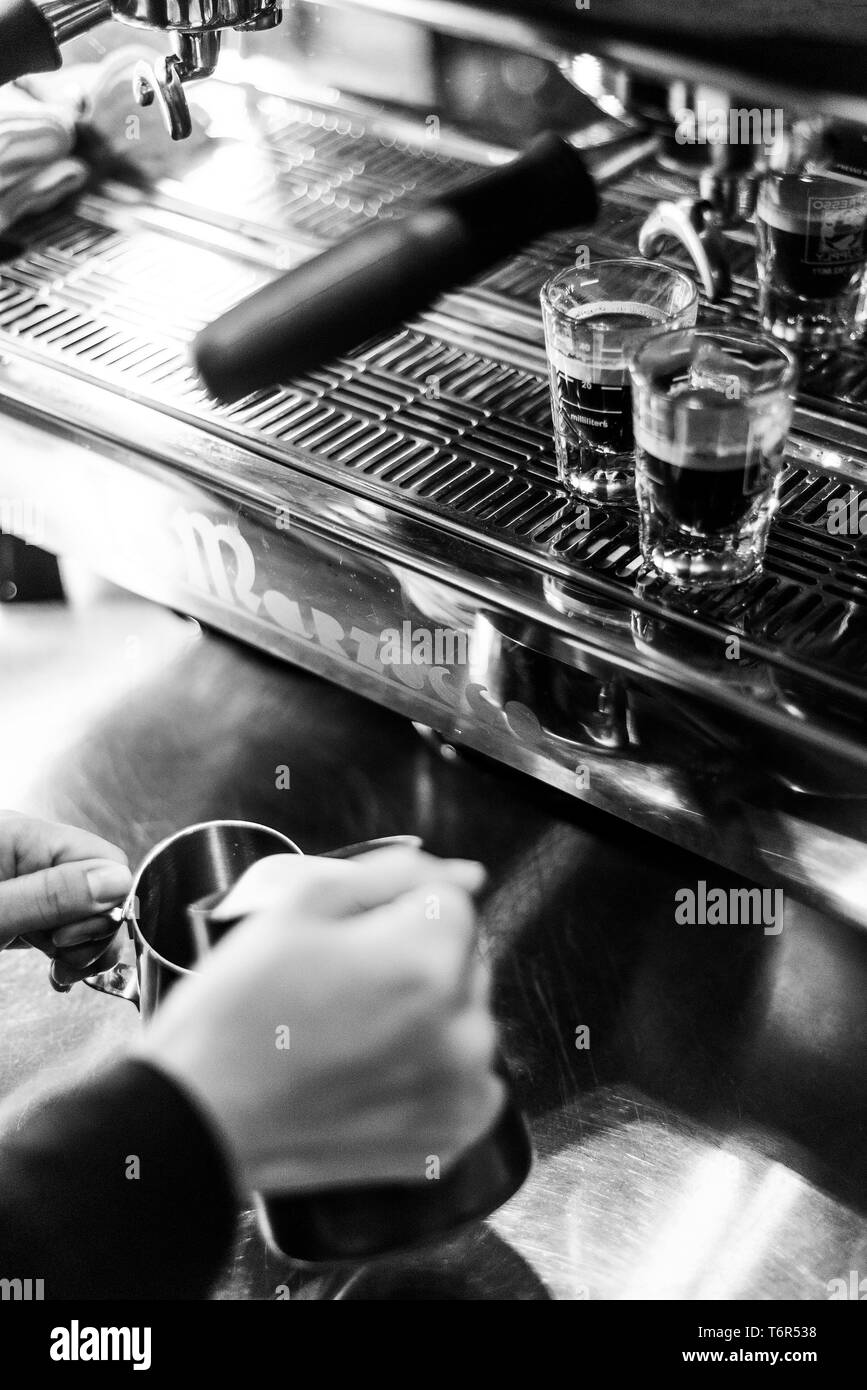 making espresso coffee BW black and white close up detail with modern ...