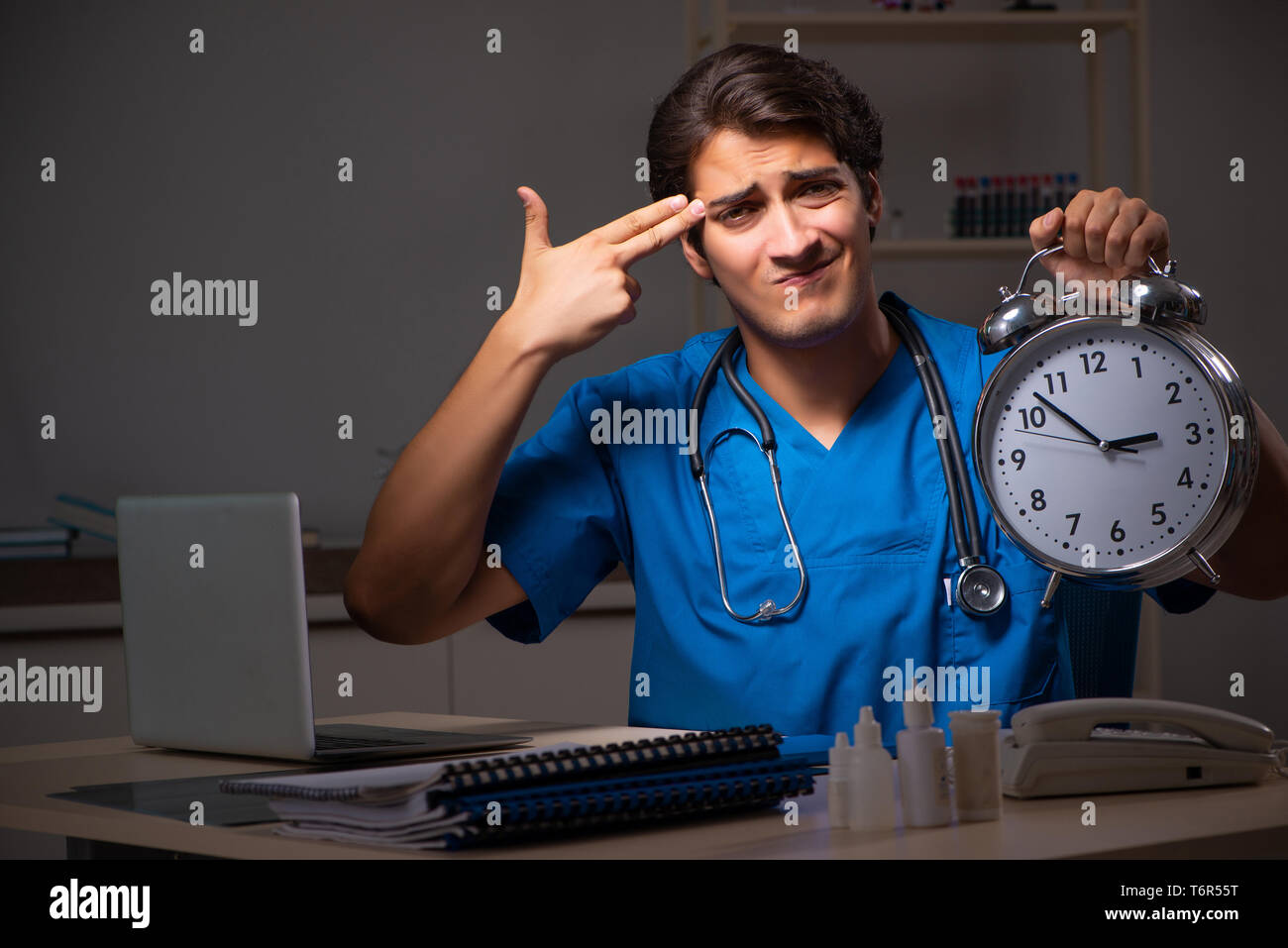 Young handsome doctor working night shift in hospital Stock Photo - Alamy