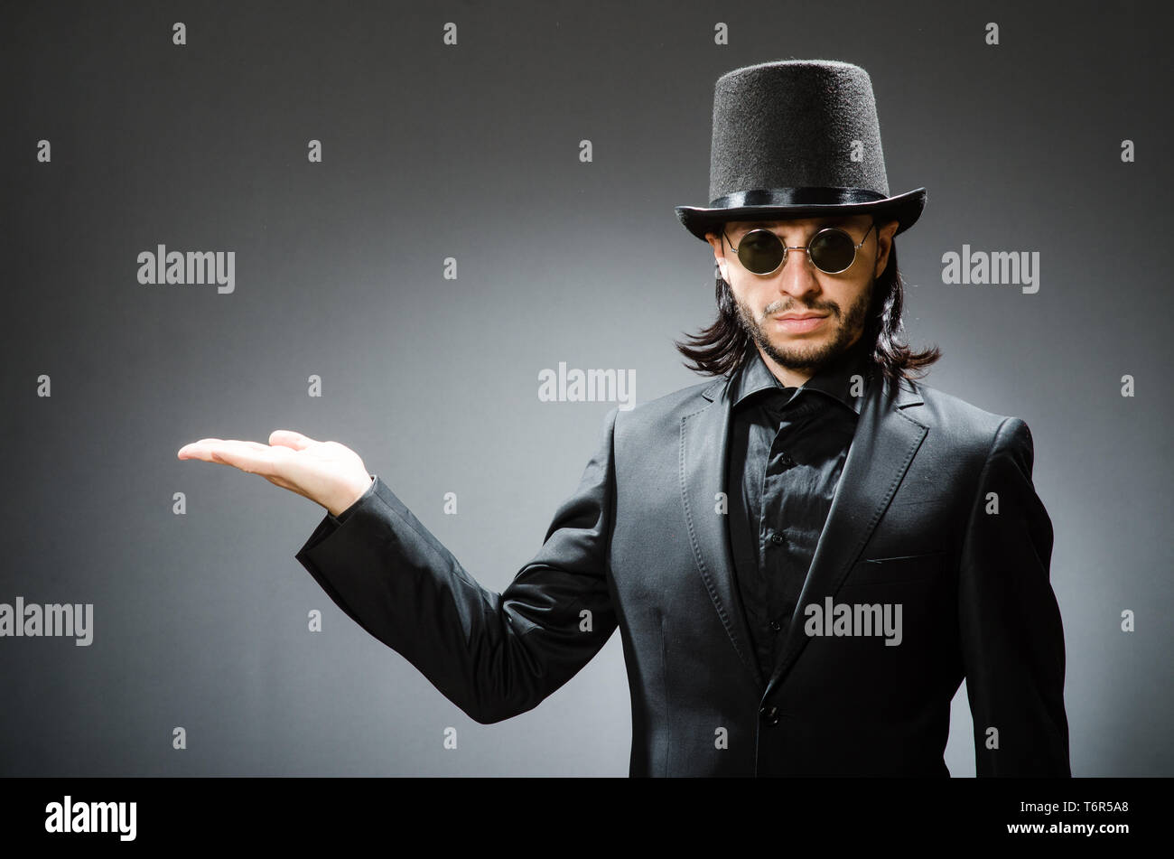 Vintage concept with man wearing black top hat Stock Photo - Alamy
