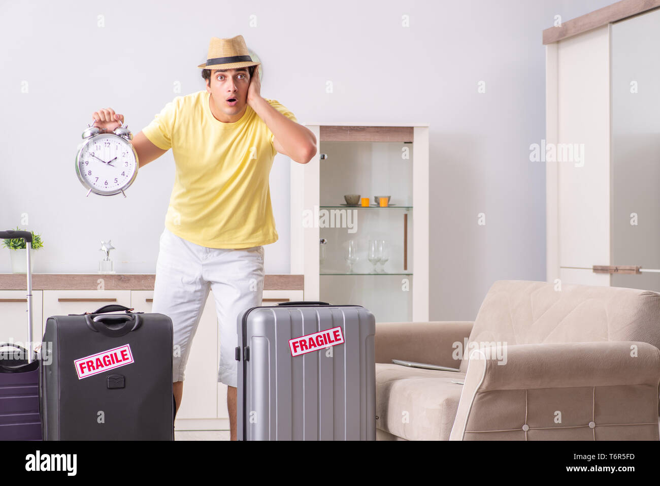 Man going on vacation with fragile suitcases Stock Photo - Alamy