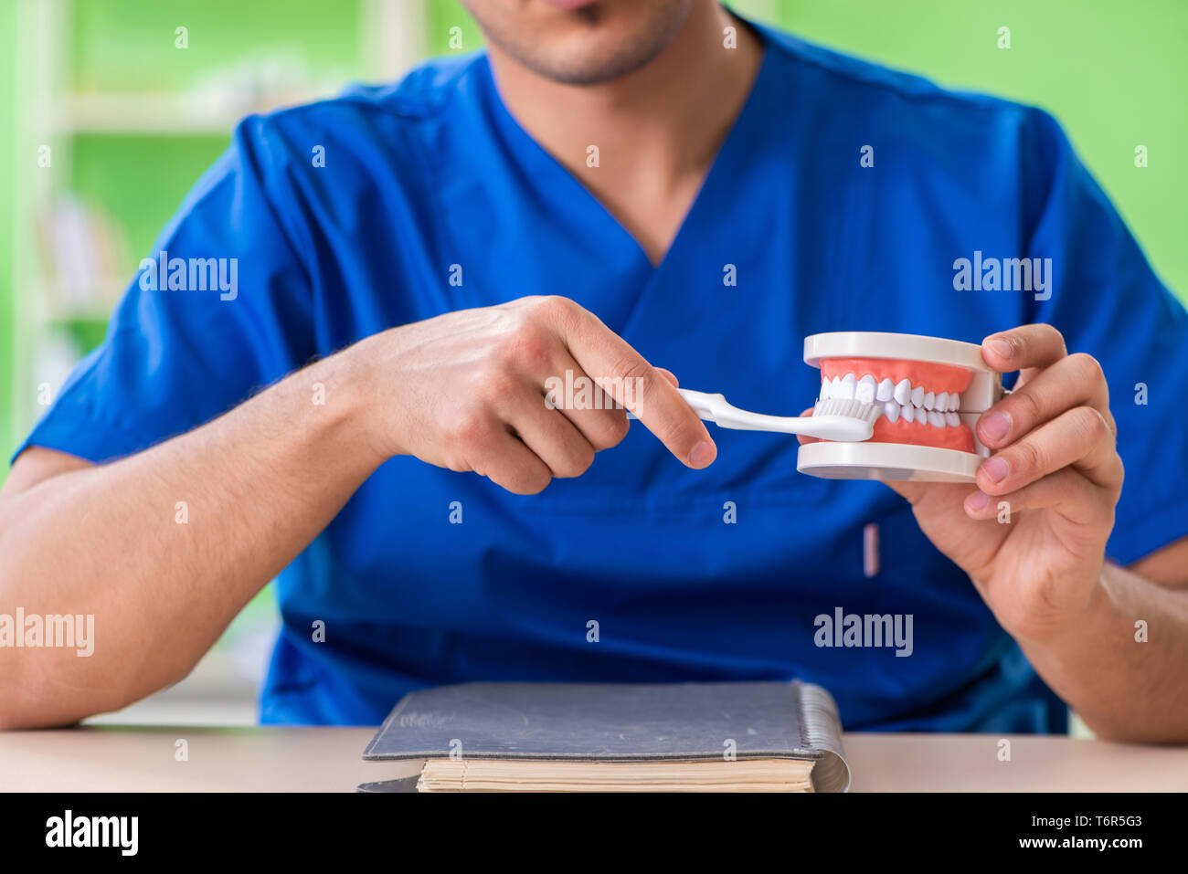 Man dentist working on new teeth implant Stock Photo - Alamy