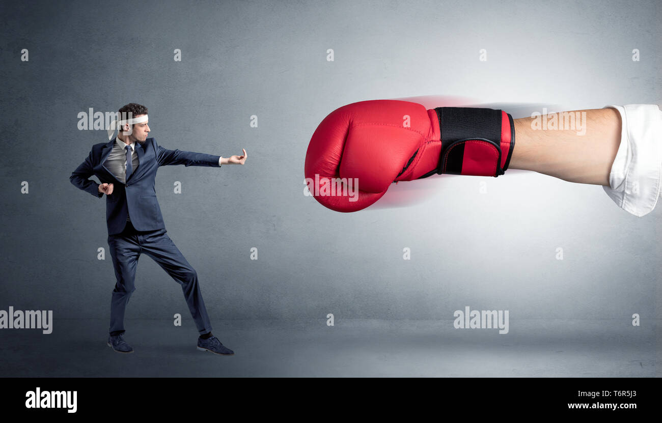 Little man fighting with a giant red boxing glove Stock Photo - Alamy