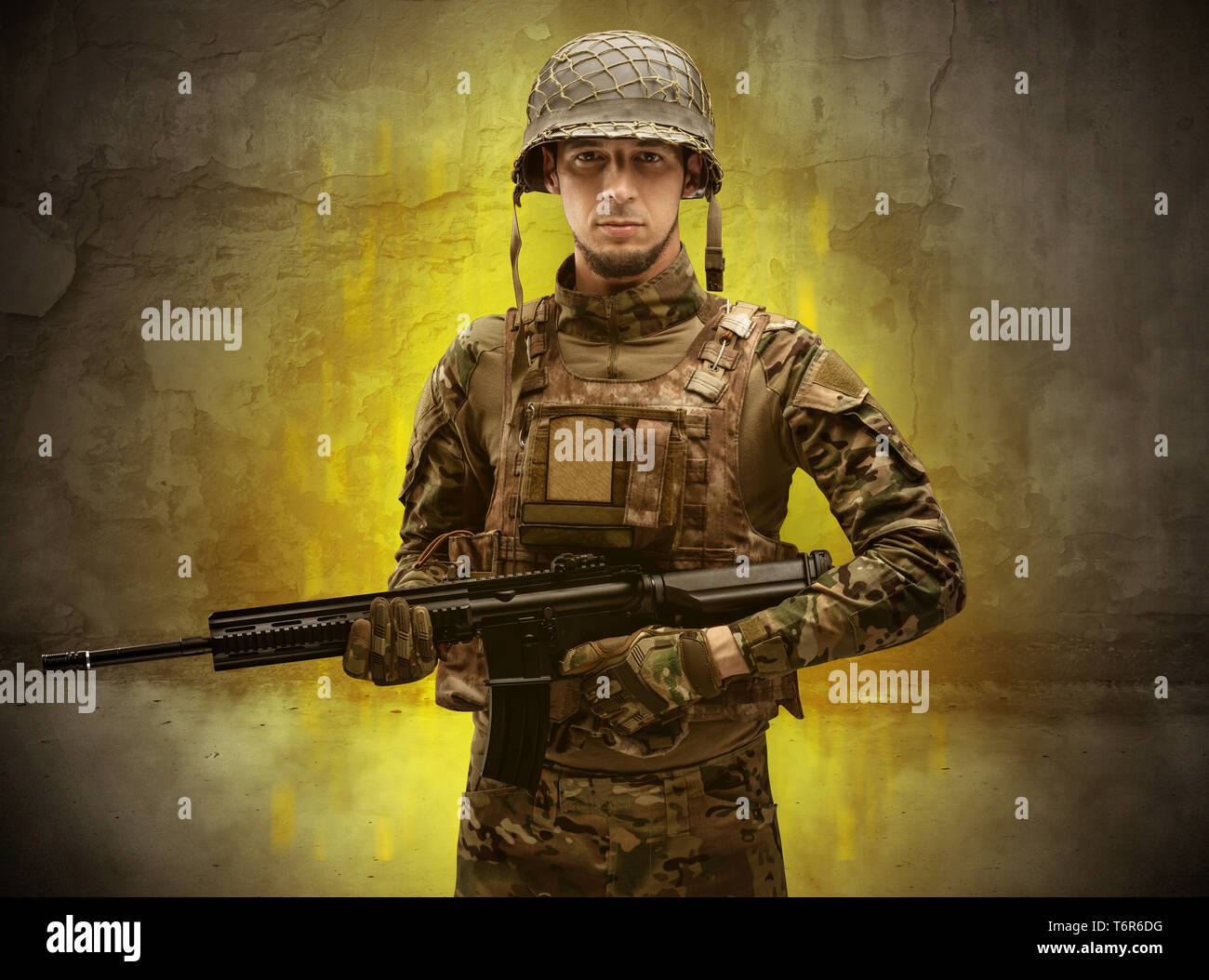 Hazard, menace soldier in a ruined crumbly building with arms on his ...