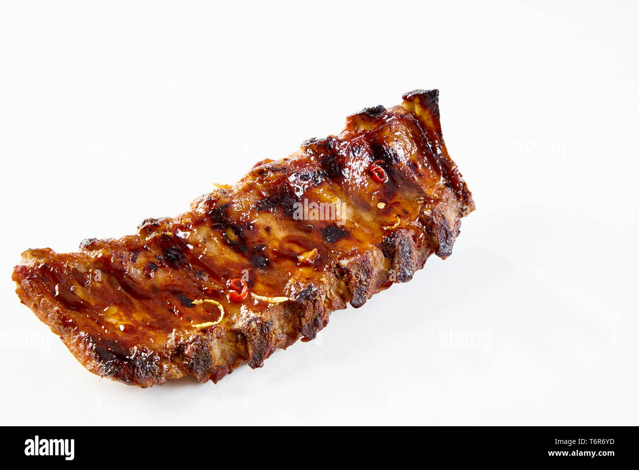 Barbecued and marinated sticky spare ribs on a white background with ...