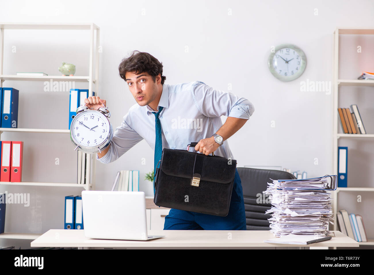 Overloaded busy employee with too much work and paperwork Stock Photo ...