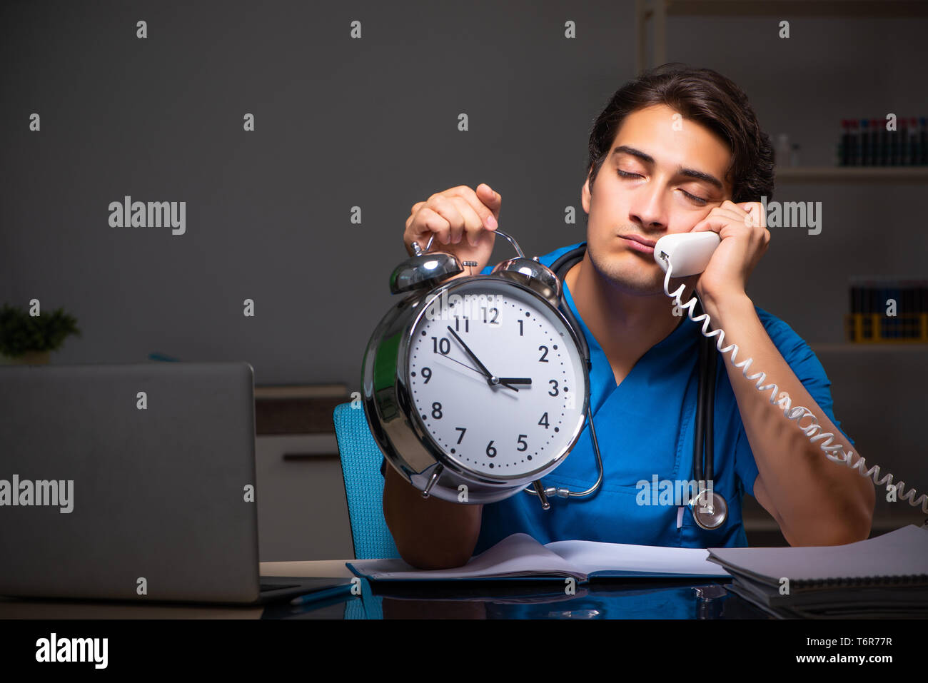 Young handsome doctor working night shift in hospital Stock Photo - Alamy