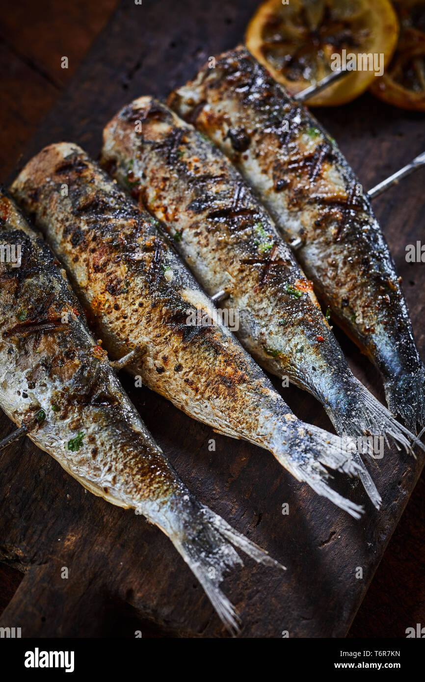 Grilled fish on metal skewers in close-up viewed from above Stock Photo ...