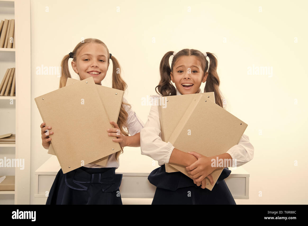 Small girls prepare for future profession in office. Happy small girls ...