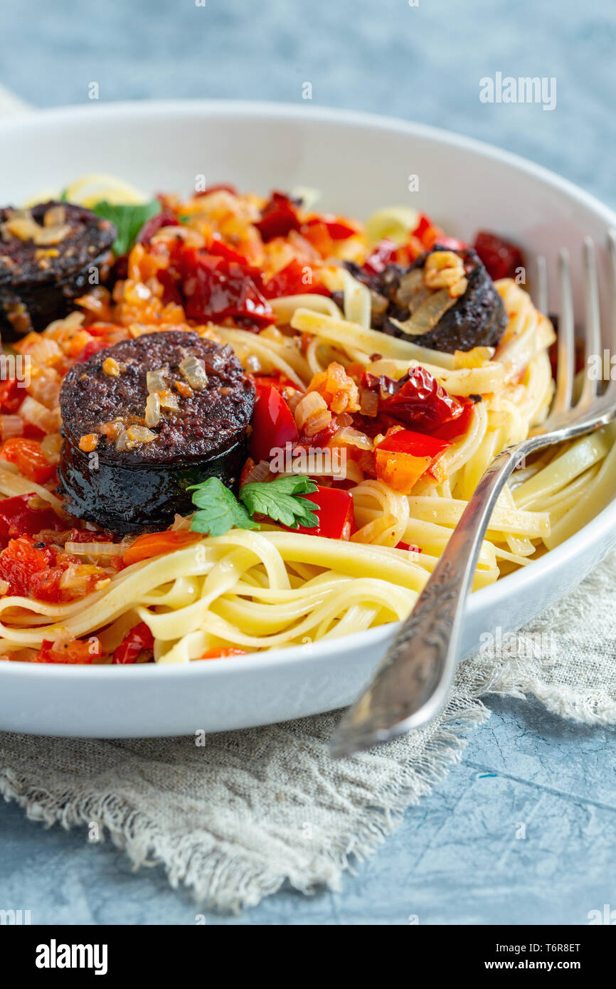 Italian pasta with tomato sauce and blood sausages Stock Photo - Alamy