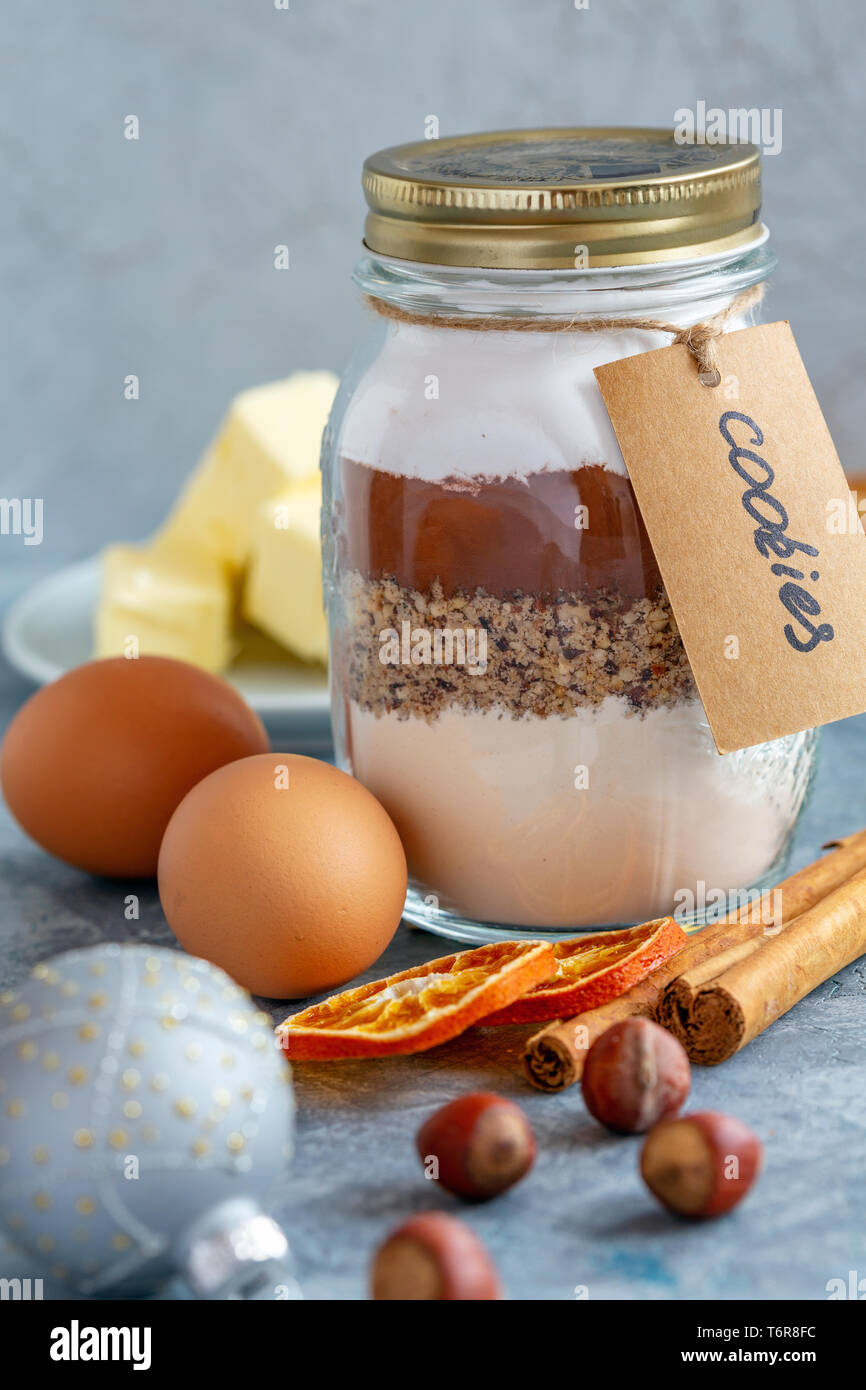 Glass jar with ingredients for baking chocolate nut cookies Stock Photo ...