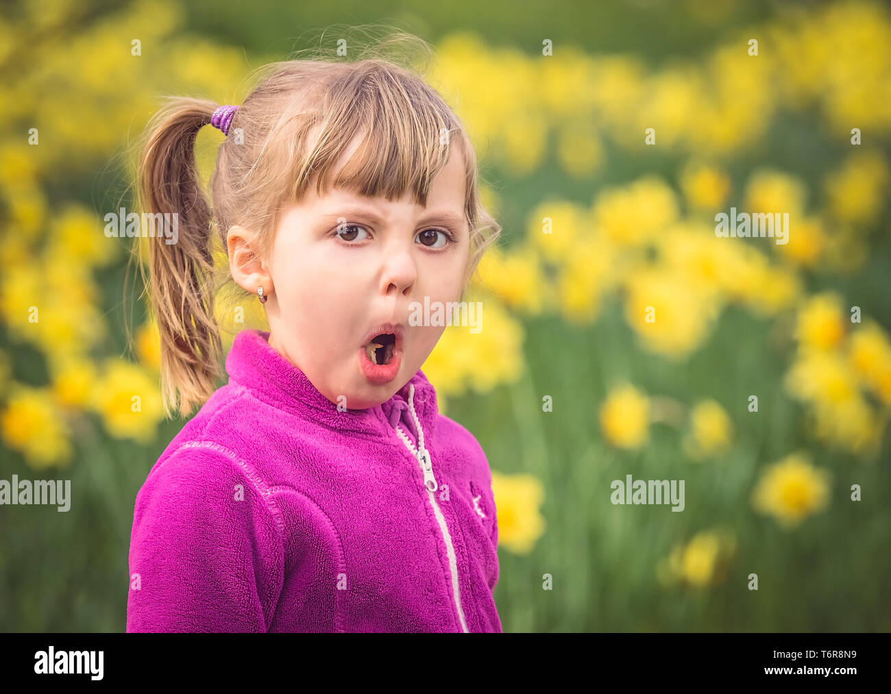 Portrait of a young mischievous girl Stock Photo - Alamy