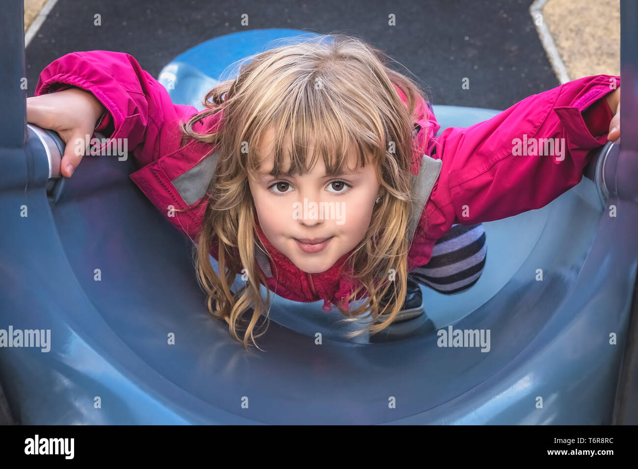 Child climbing up slide hi-res stock photography and images - Alamy
