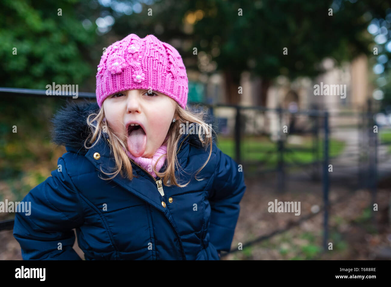 Cute naughty girl with pink hat Stock Photo - Alamy