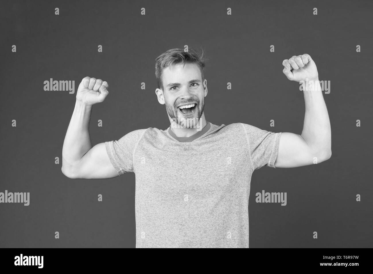 Strong and full of energy. Man strong handsome unshaven guy on violet ...