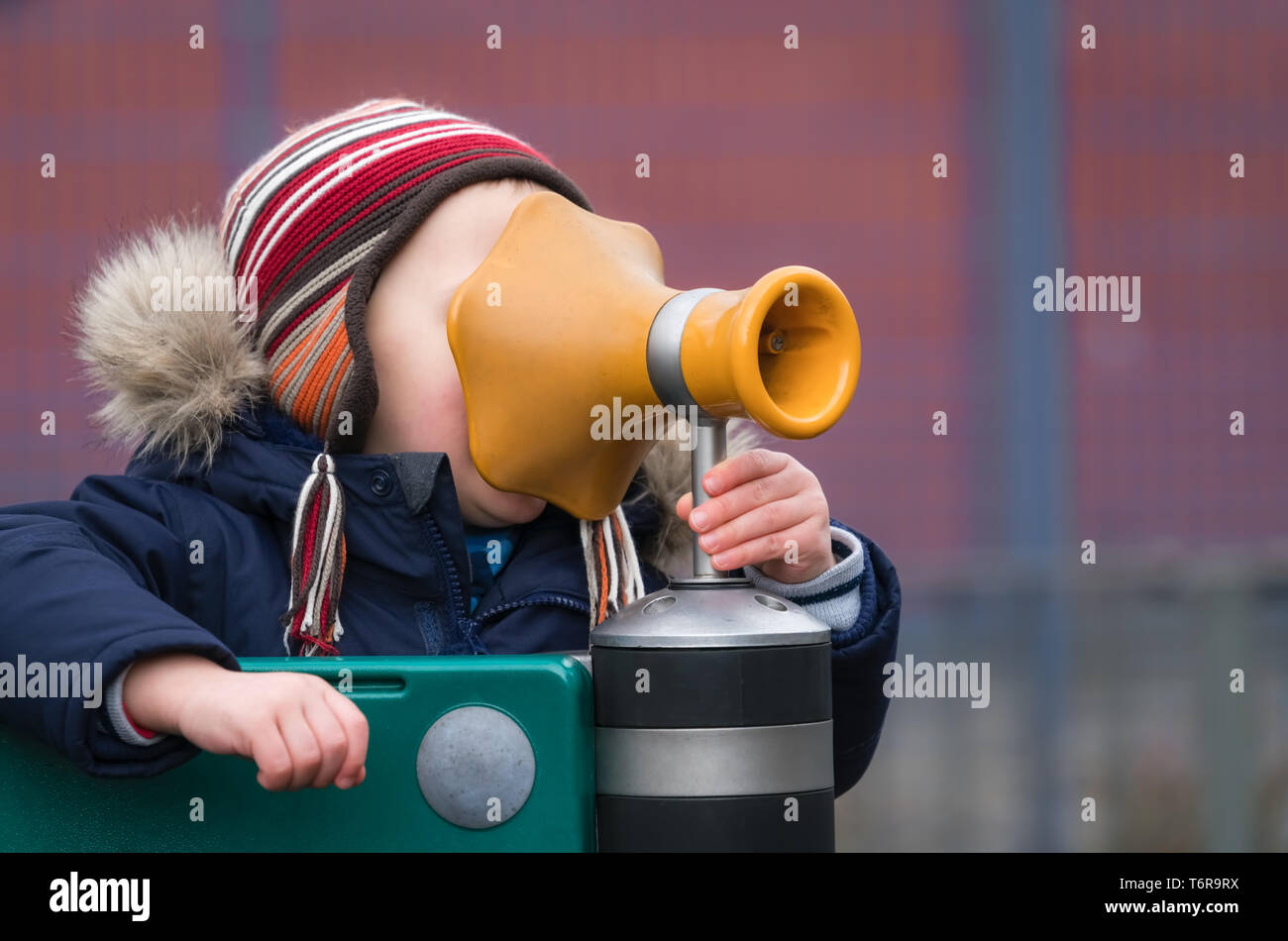 Little boy shouting inside a megaphone Stock Photo - Alamy