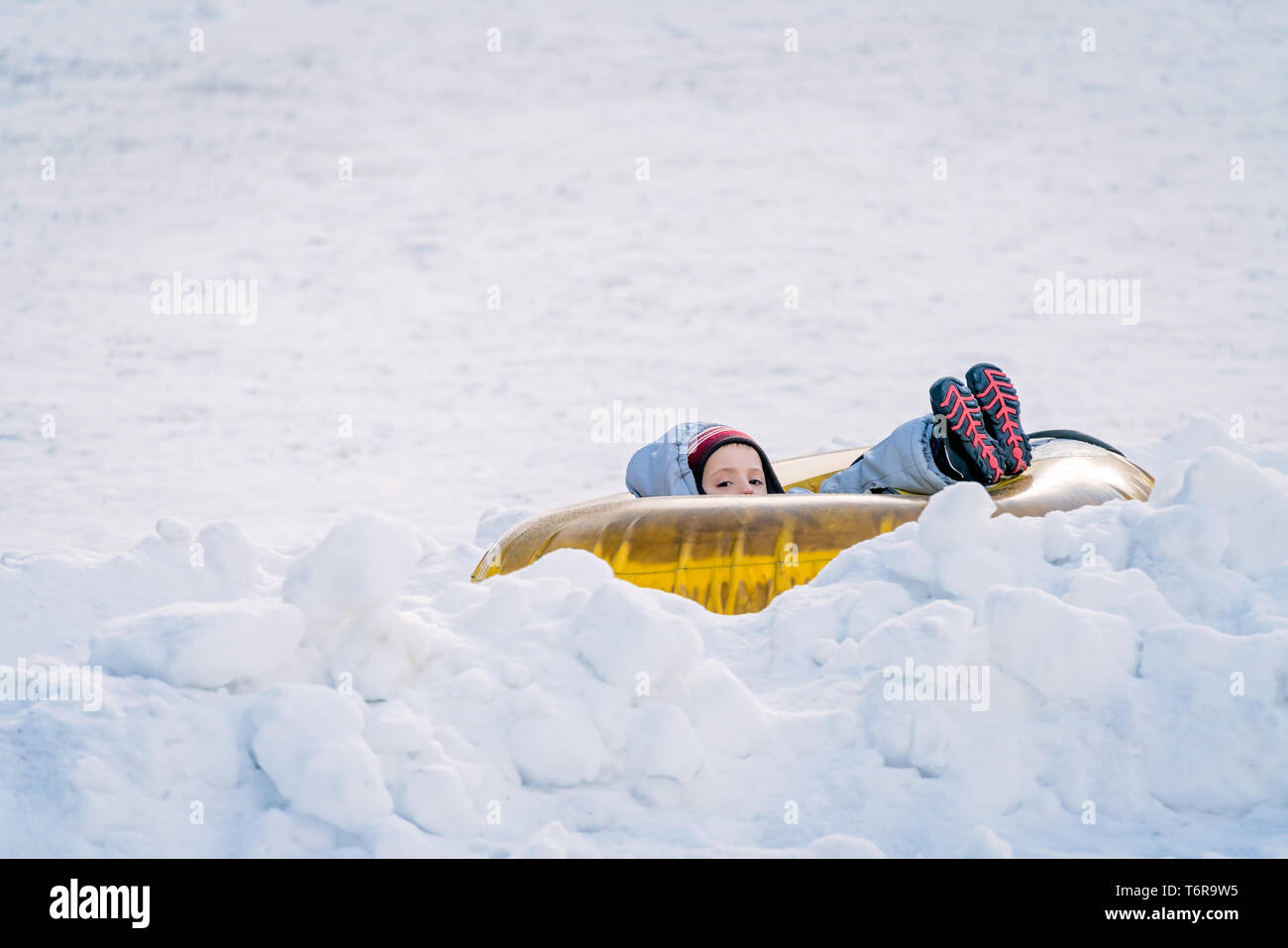Boy sledding down hill hi-res stock photography and images - Alamy