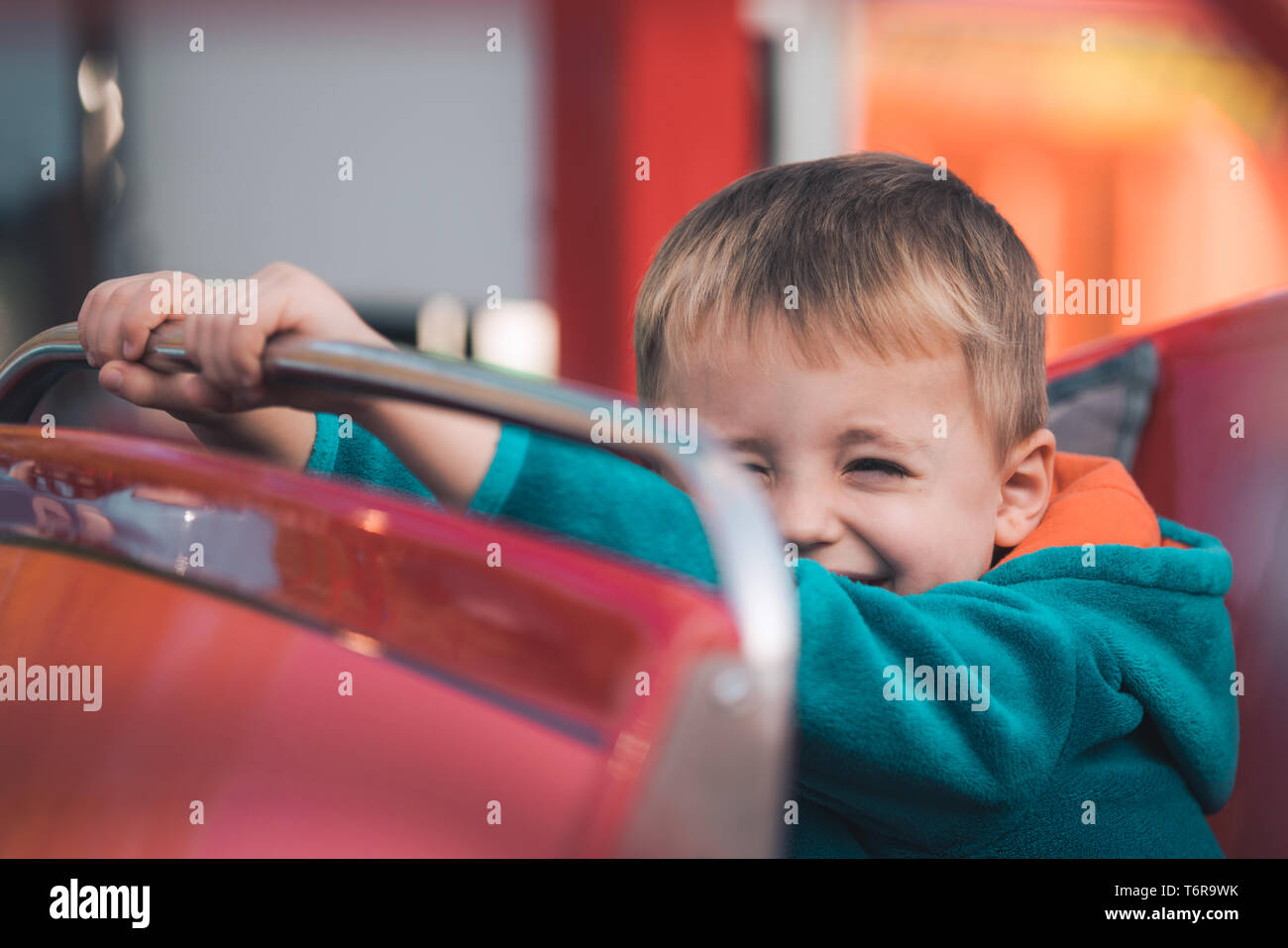 Little boy in a carousel car Stock Photo - Alamy