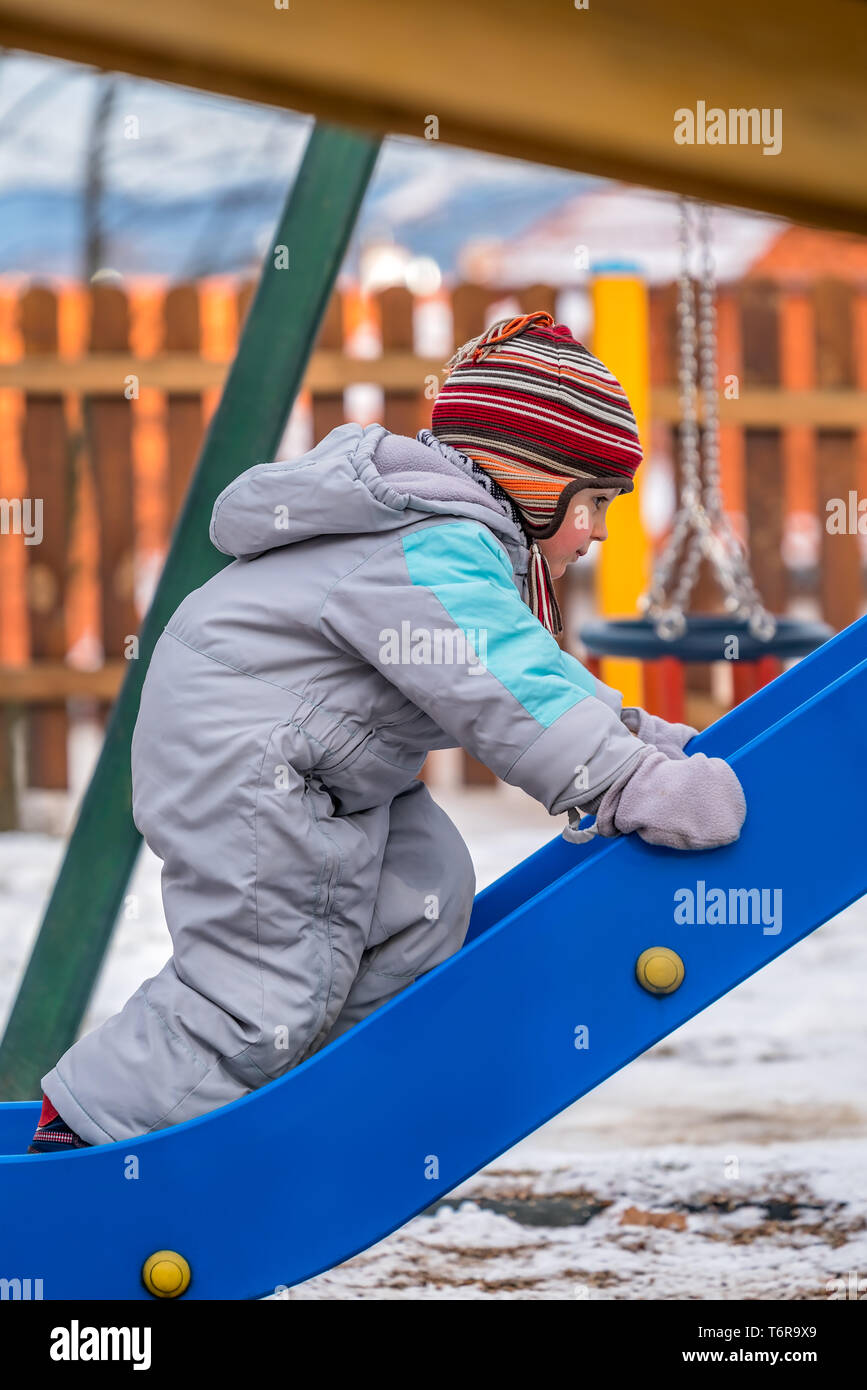 Child climbing up slide hi-res stock photography and images - Alamy