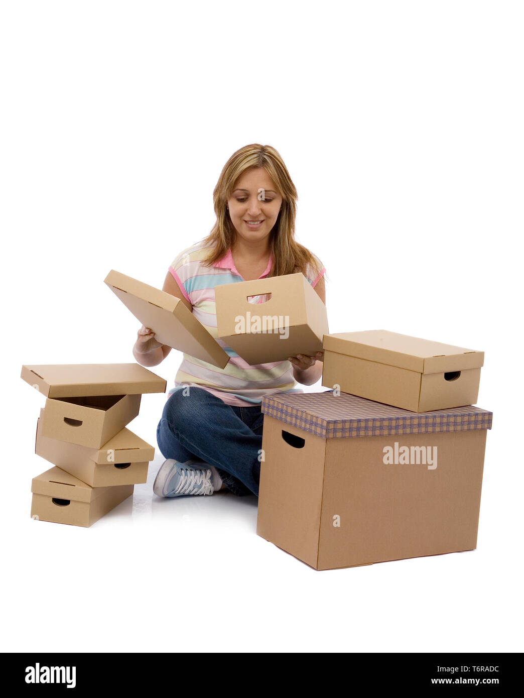 young girl unpacking cardboards on white background Stock Photo - Alamy
