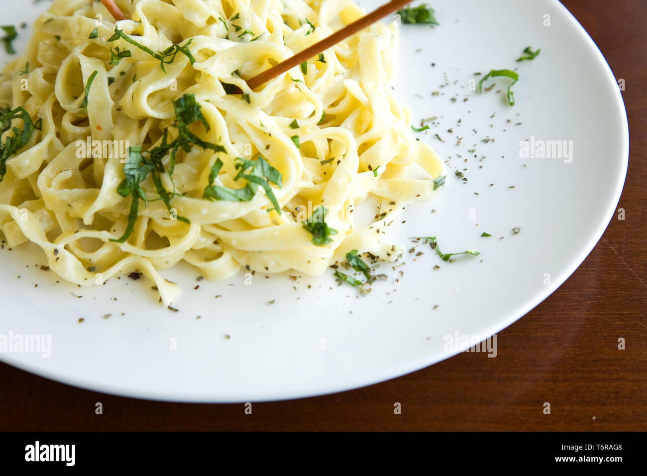 Spaghetti on table with sauce Stock Photo - Alamy