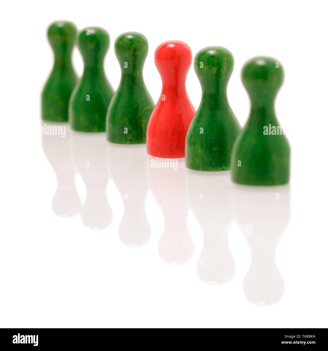 Row of wooden green figures and one red figure. Teamwork, balance and ...