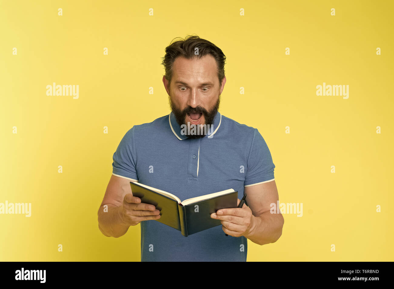Surprise concept. Bearded man shocked with surprise. Senior man reading ...
