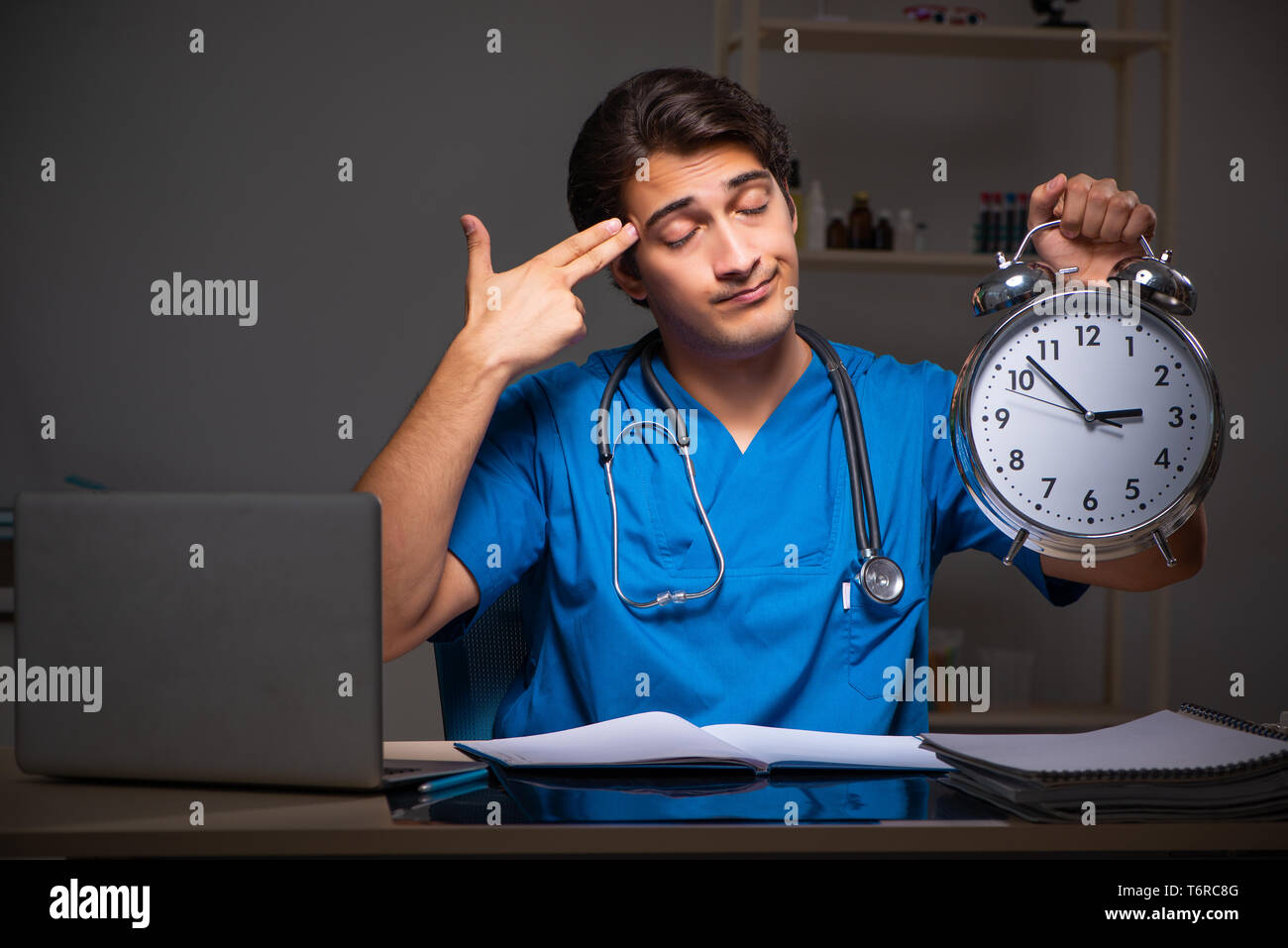 Young handsome doctor working night shift in hospital Stock Photo - Alamy