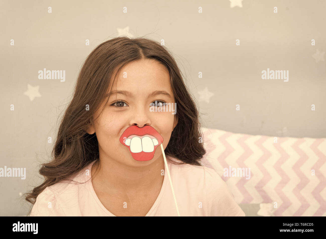 Slumber party photo booth props. Kid girl cheerful posing with toothy ...