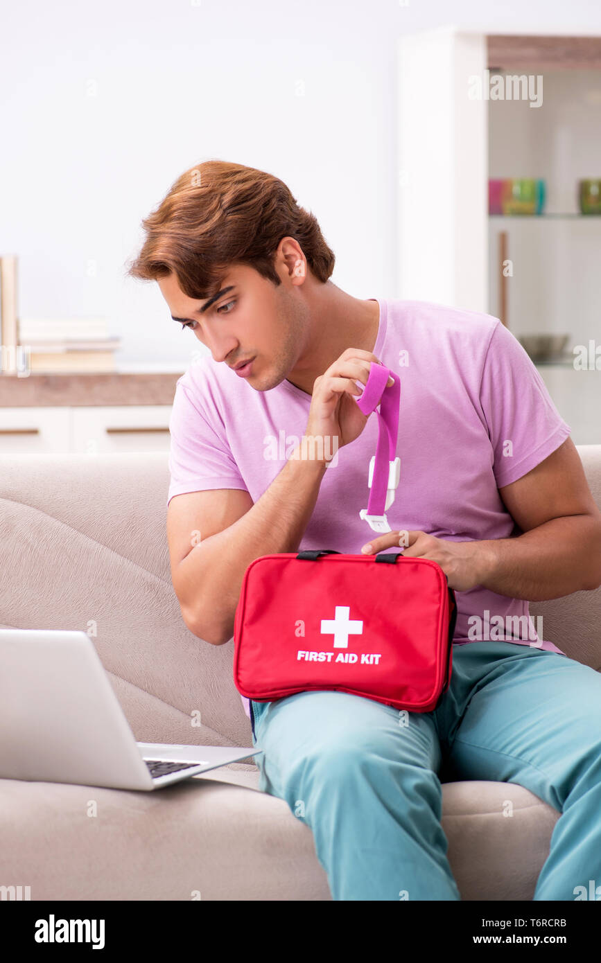 Sick man at home with first aid kit Stock Photo - Alamy