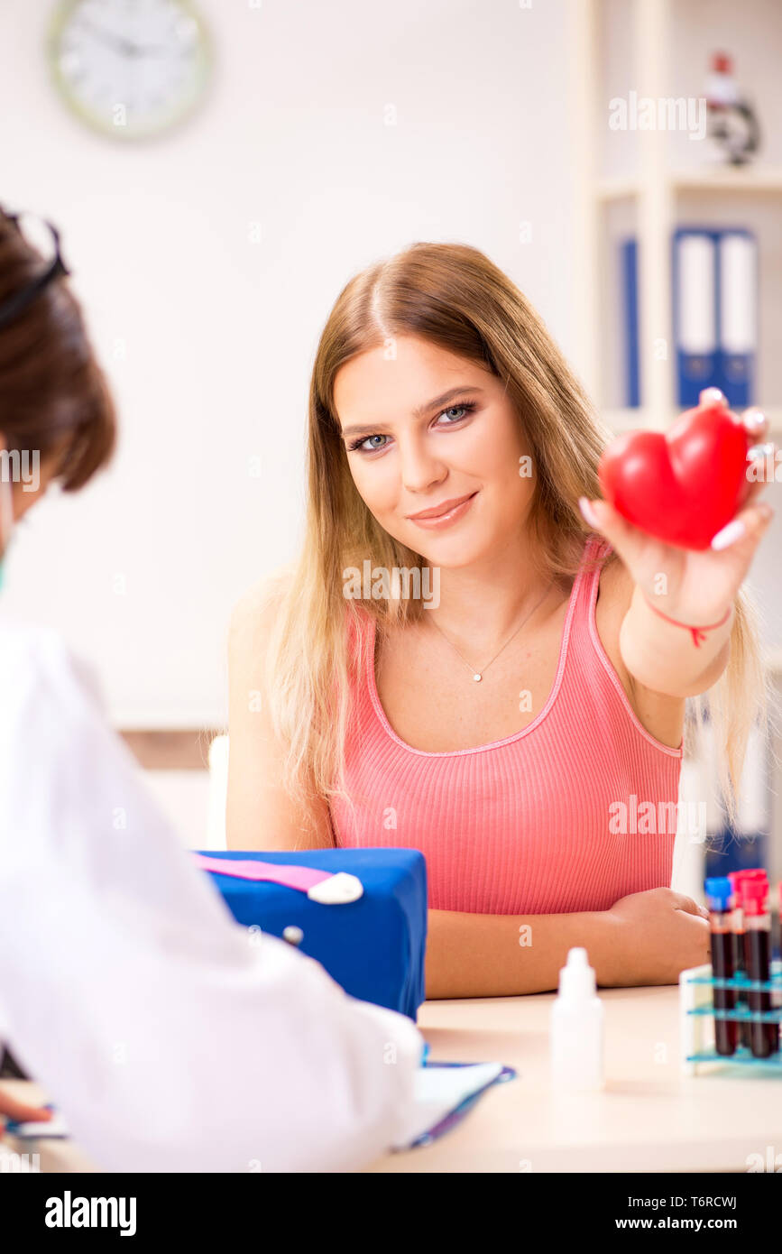 Young beautiful woman during blood test sampling procedure Stock Photo ...