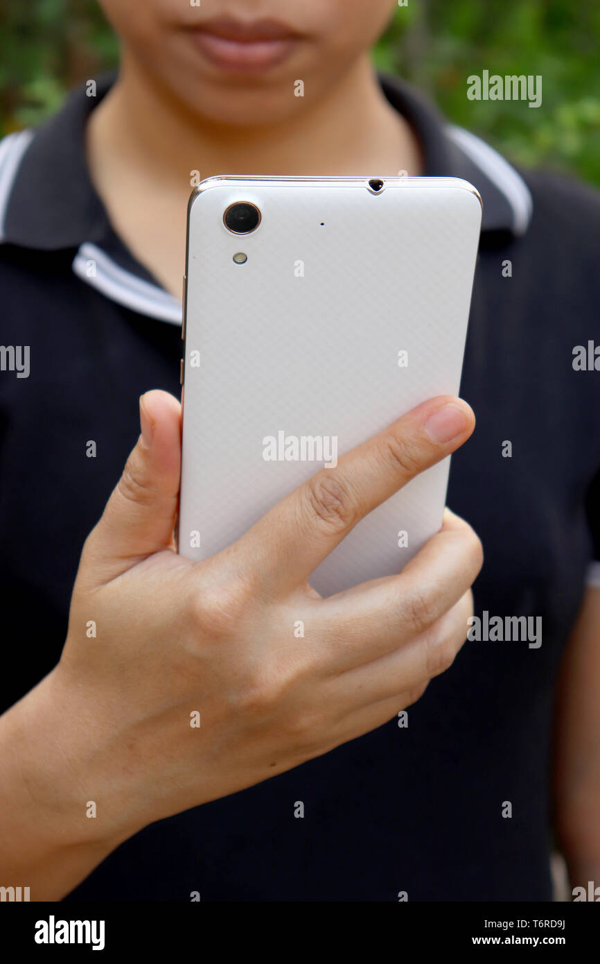 Asian woman holding and using smart phone show back side. High ...