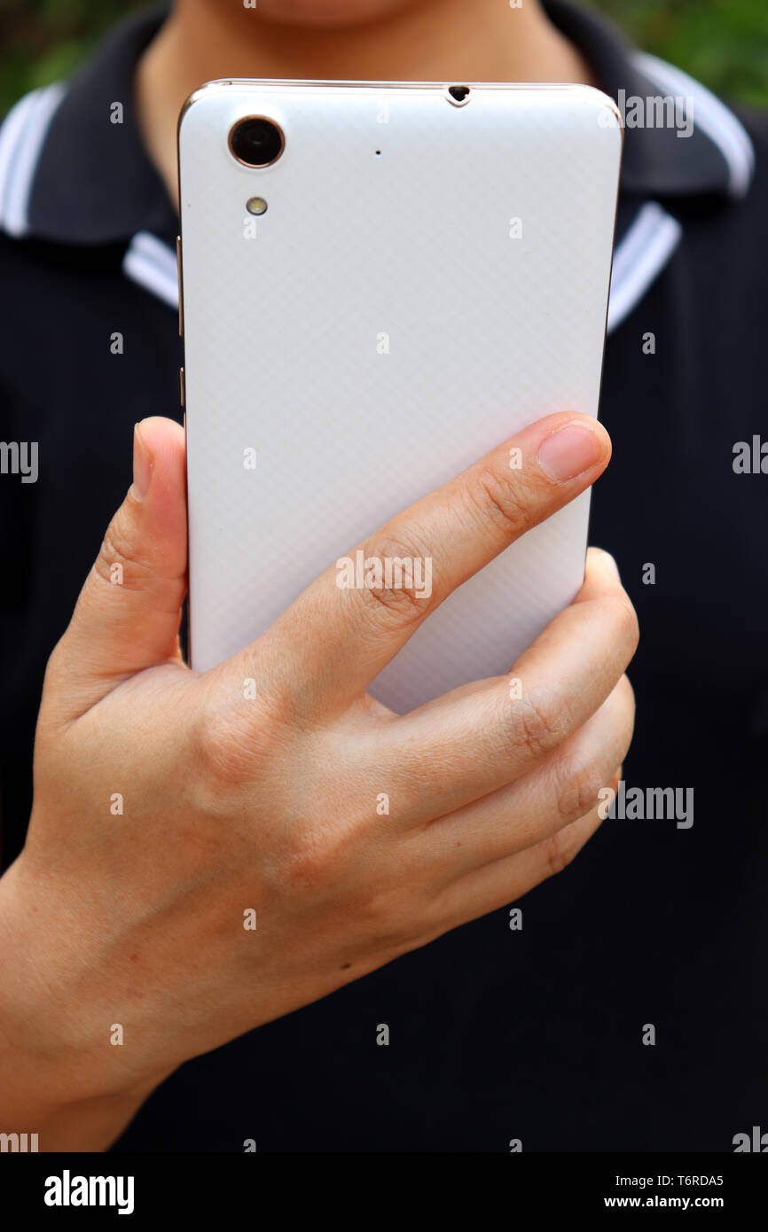 Asian woman holding and using smart phone show back side. High ...